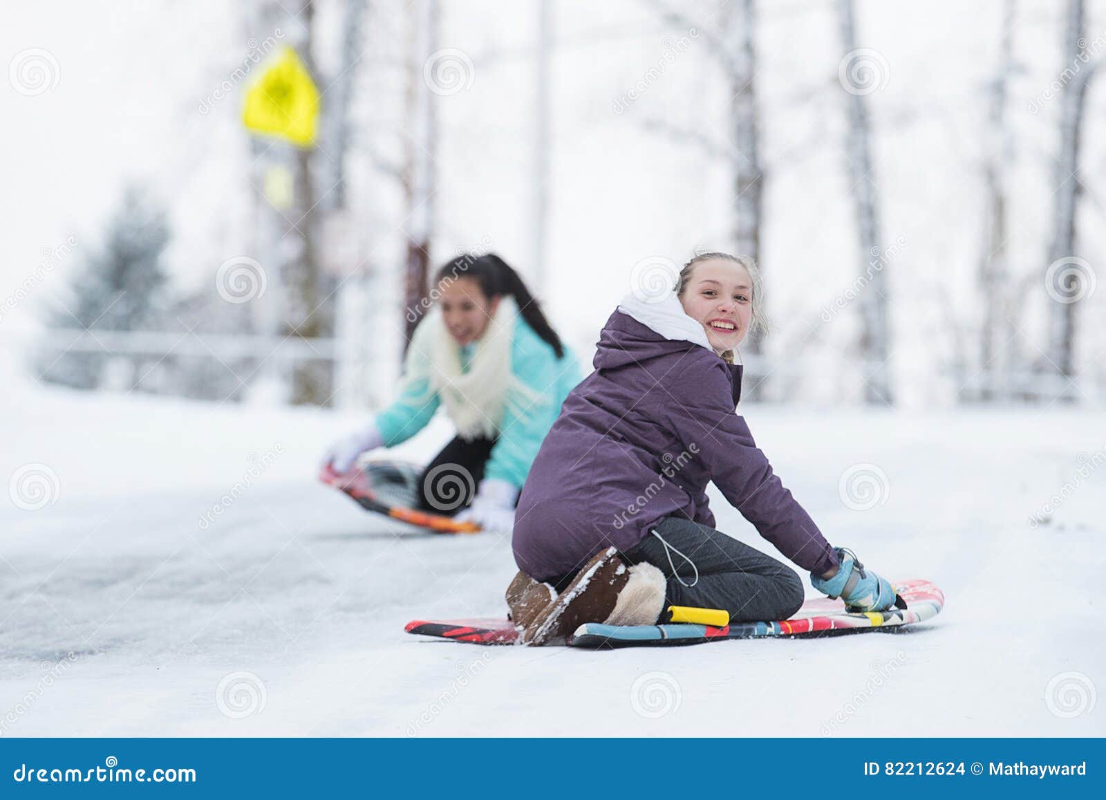 Two Kids Playing on a Snow Sled in Winter Stock Photo - Image of girls ...