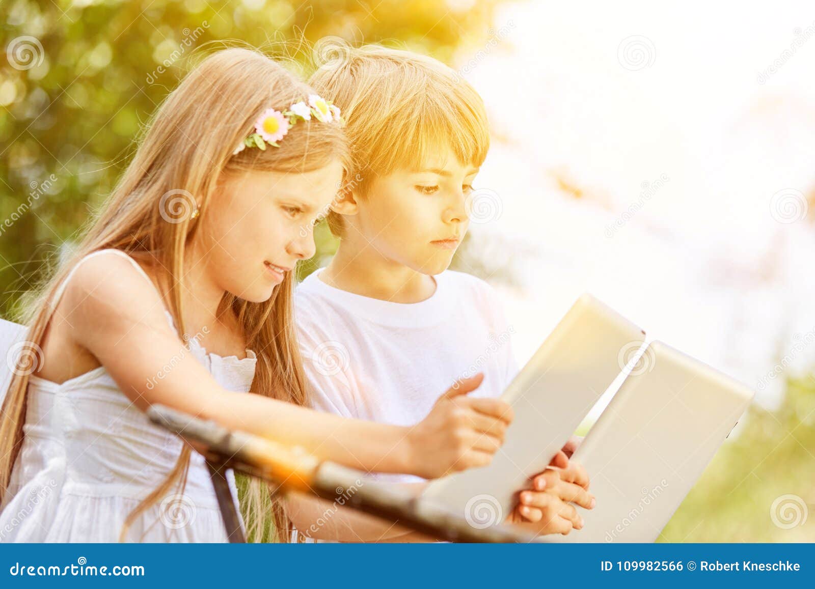 Two Kids are Playing with Tablet Computer on the Internet Stock Photo ...