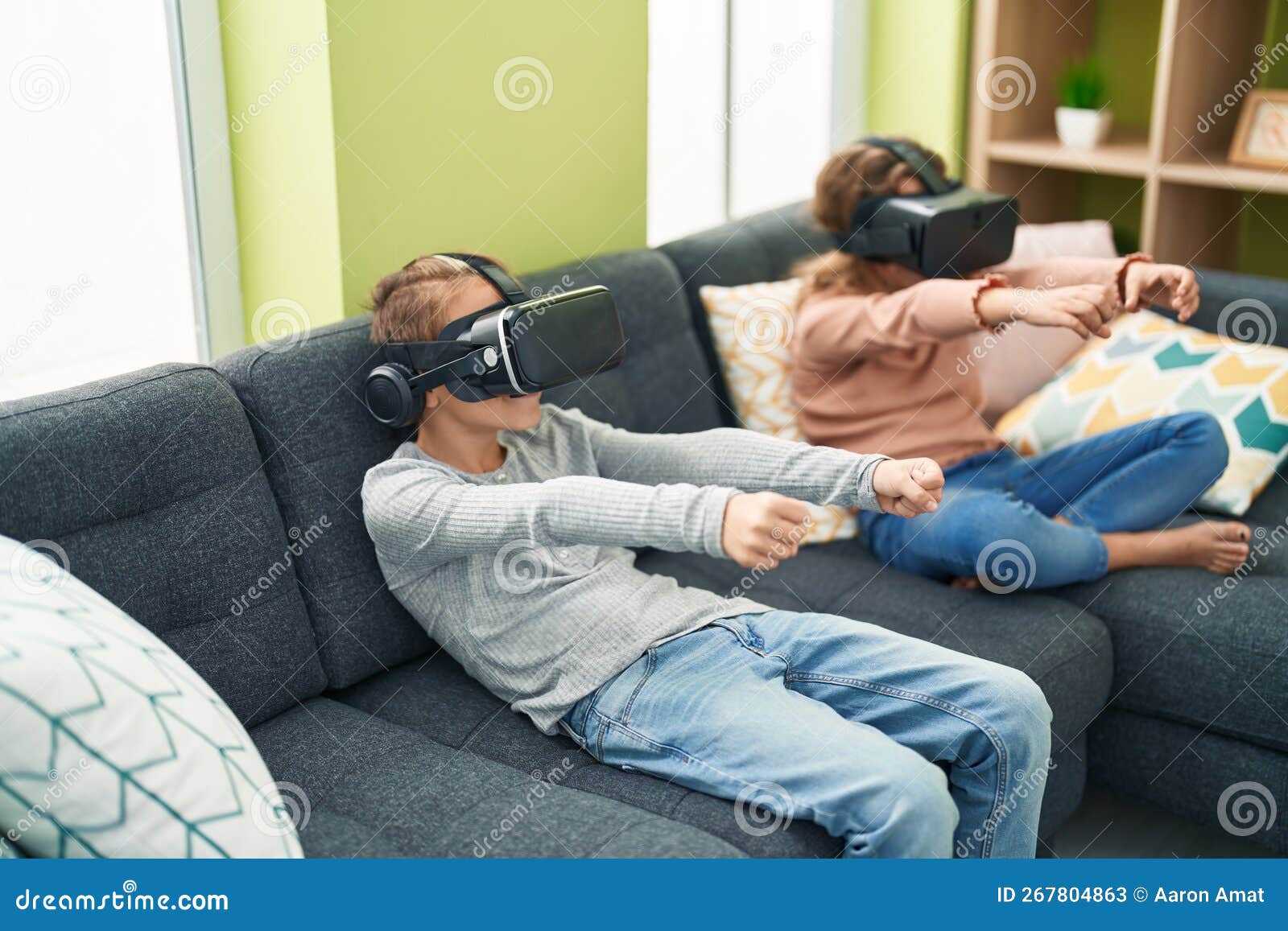 Two Kids Playing Video Game Using Virtual Reality Glasses at Home Stock ...