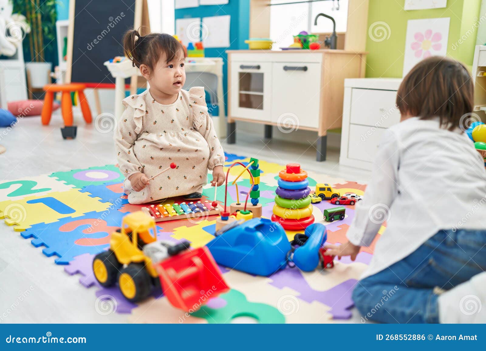 Two Kids Playing Xylophone Sitting on Floor at Kindergarten Stock Photo ...