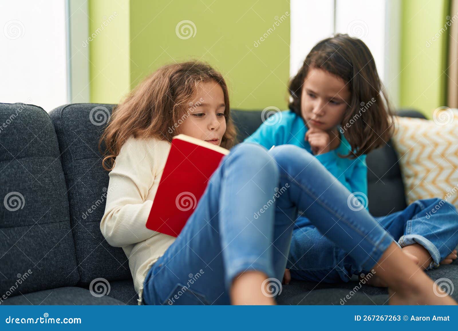 Two Kids Reading Book Sitting on Sofa at Home Stock Image - Image of ...