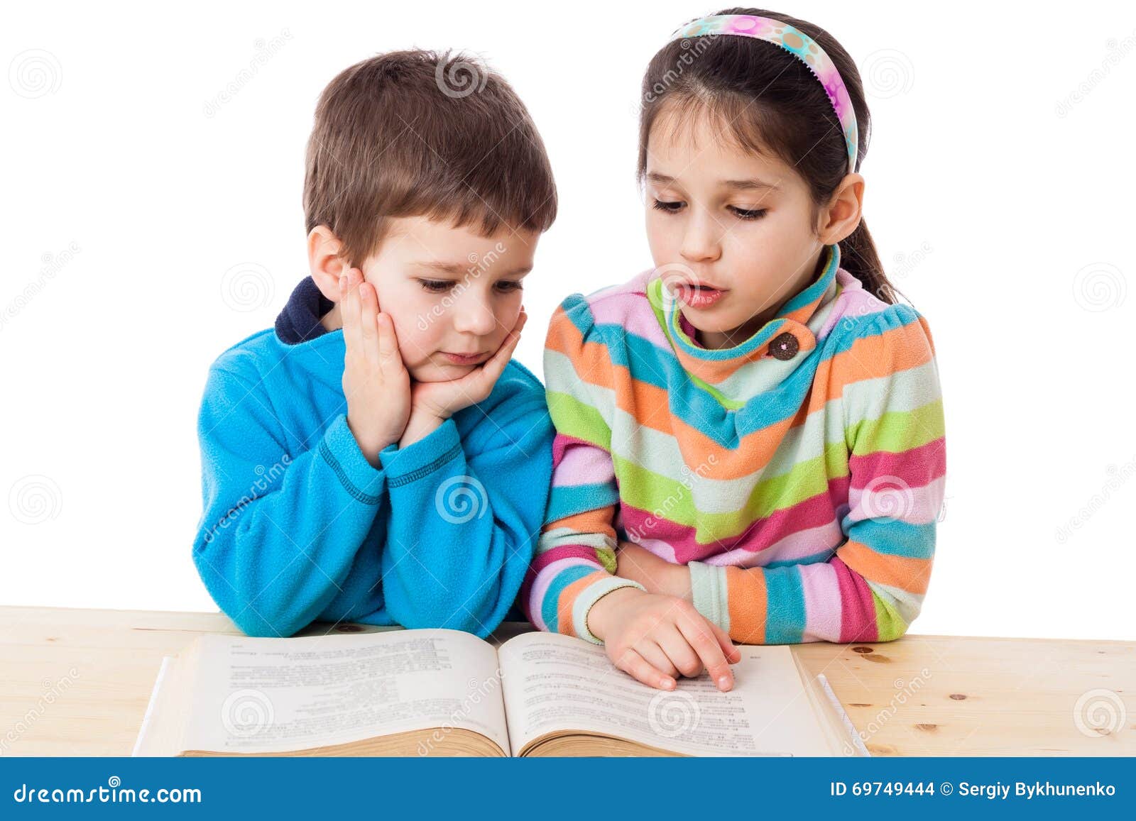 Two Kids Reading The Book At The Table Stock Photo - Image: 69749444