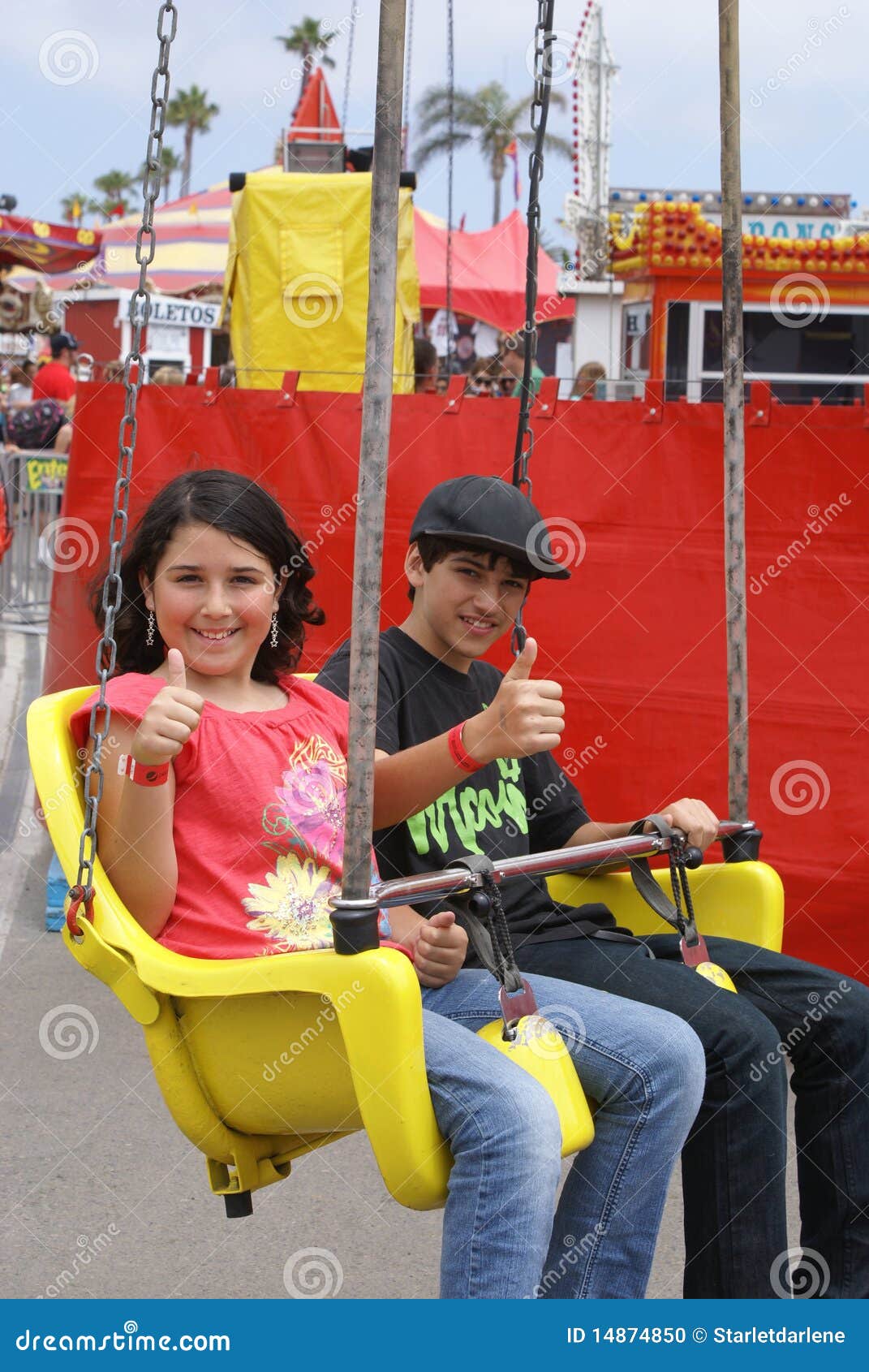 Two Kids Riding a Ride at the Fair or Carnival Stock Photo - Image of ...