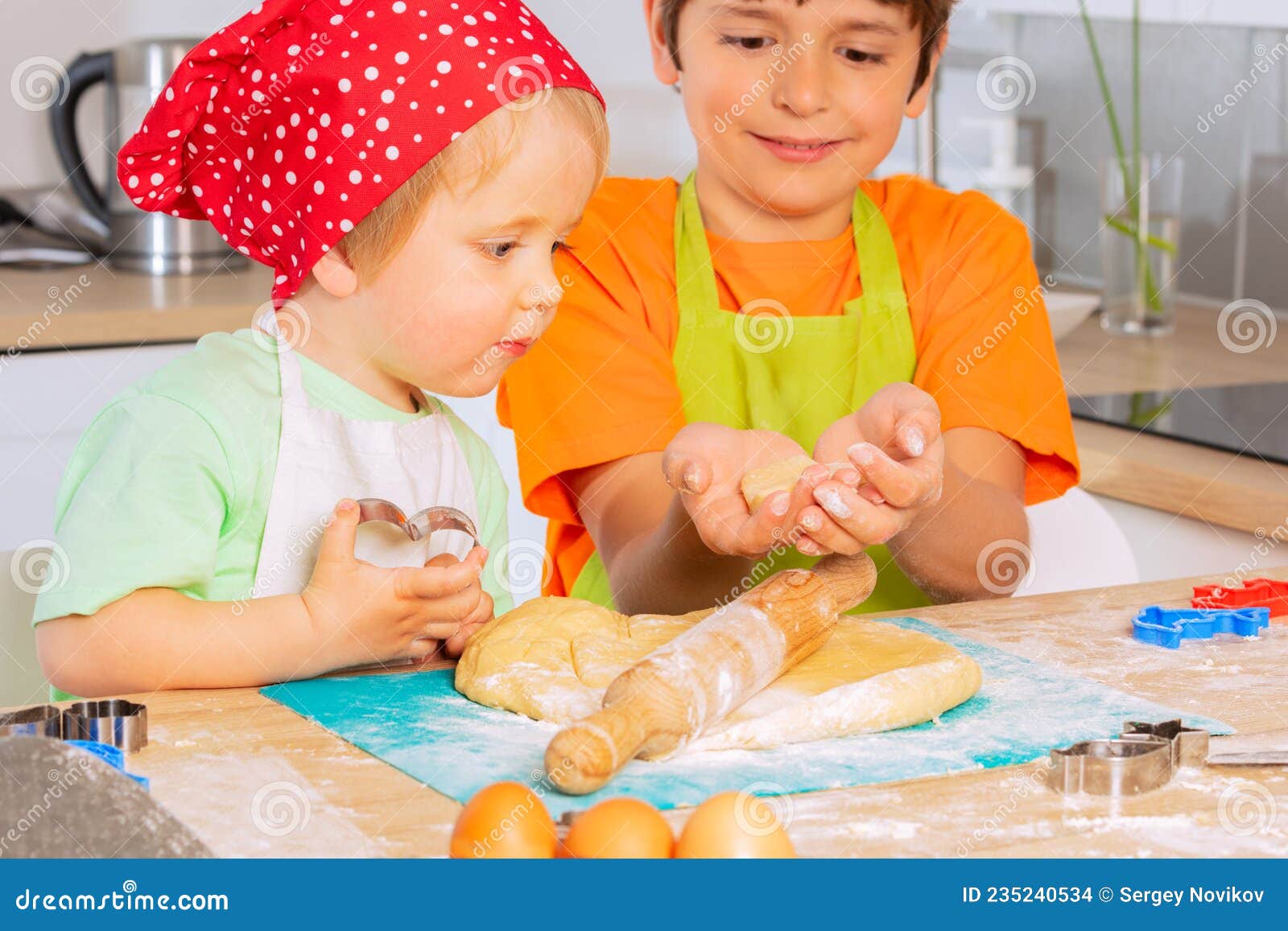 Two Kids Roll Dough and Cut Shapes on the Kitchen Stock Photo - Image ...