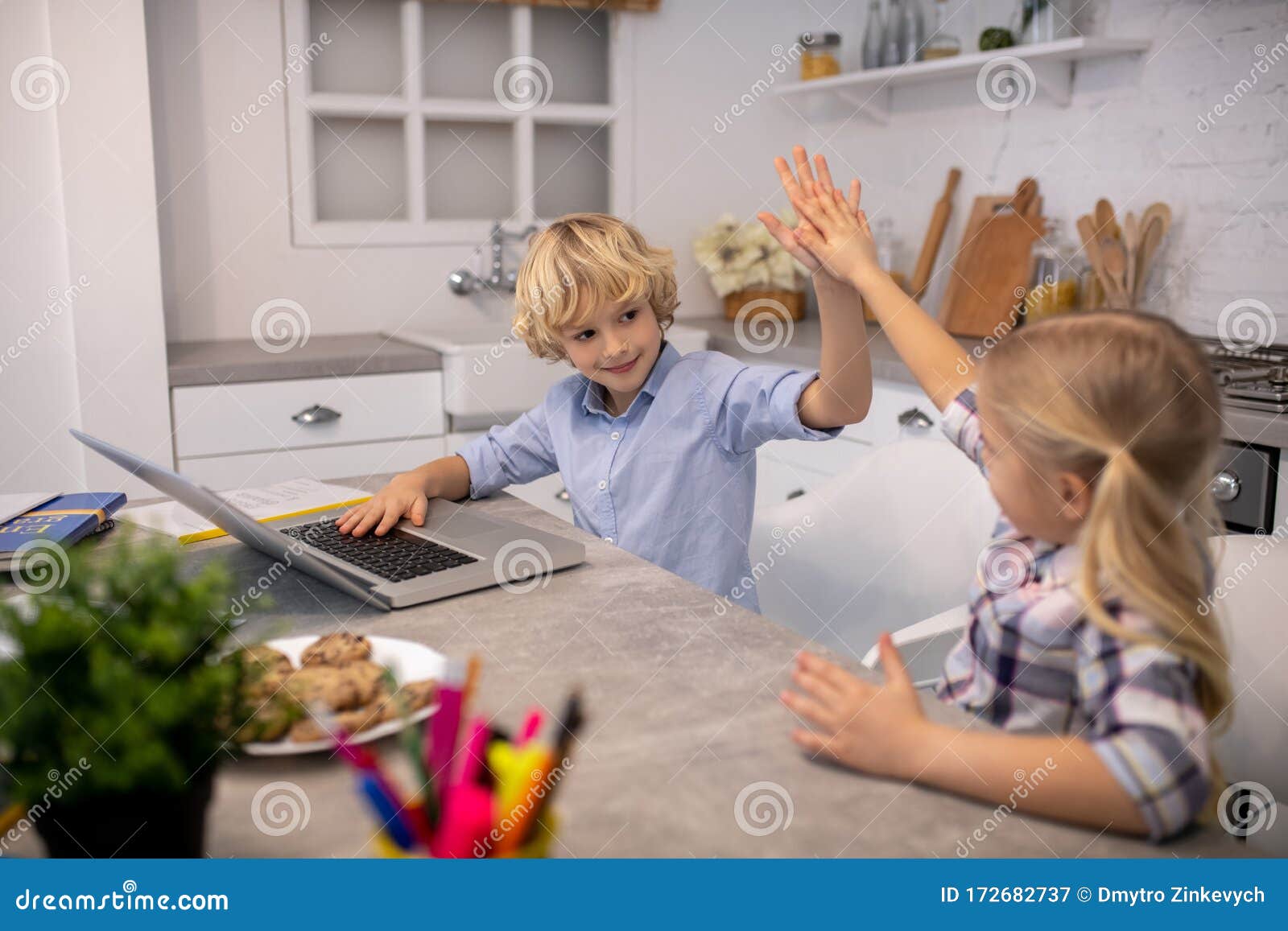 Two Kids Sitting at the Table and Making High Five Stock Image - Image ...