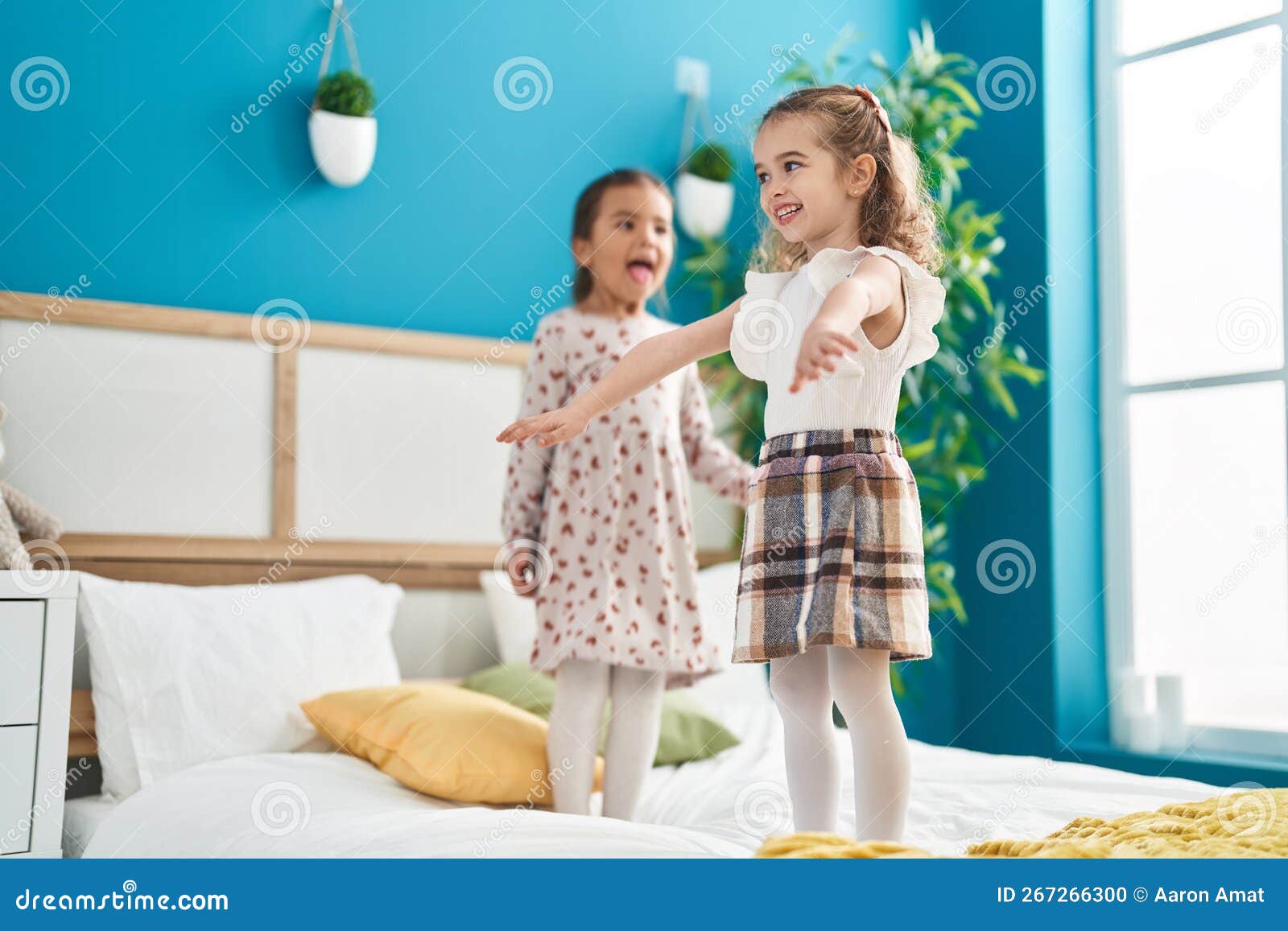 Two Kids Smiling Confident Dancing on Bed at Bedroom Stock Photo ...