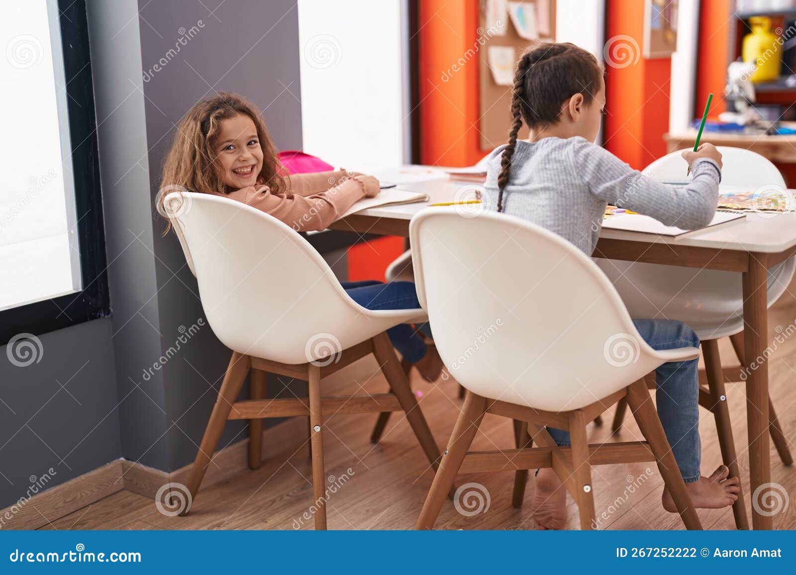 Two Kids Students Sitting on Table Drawing on Notebook Paper at ...