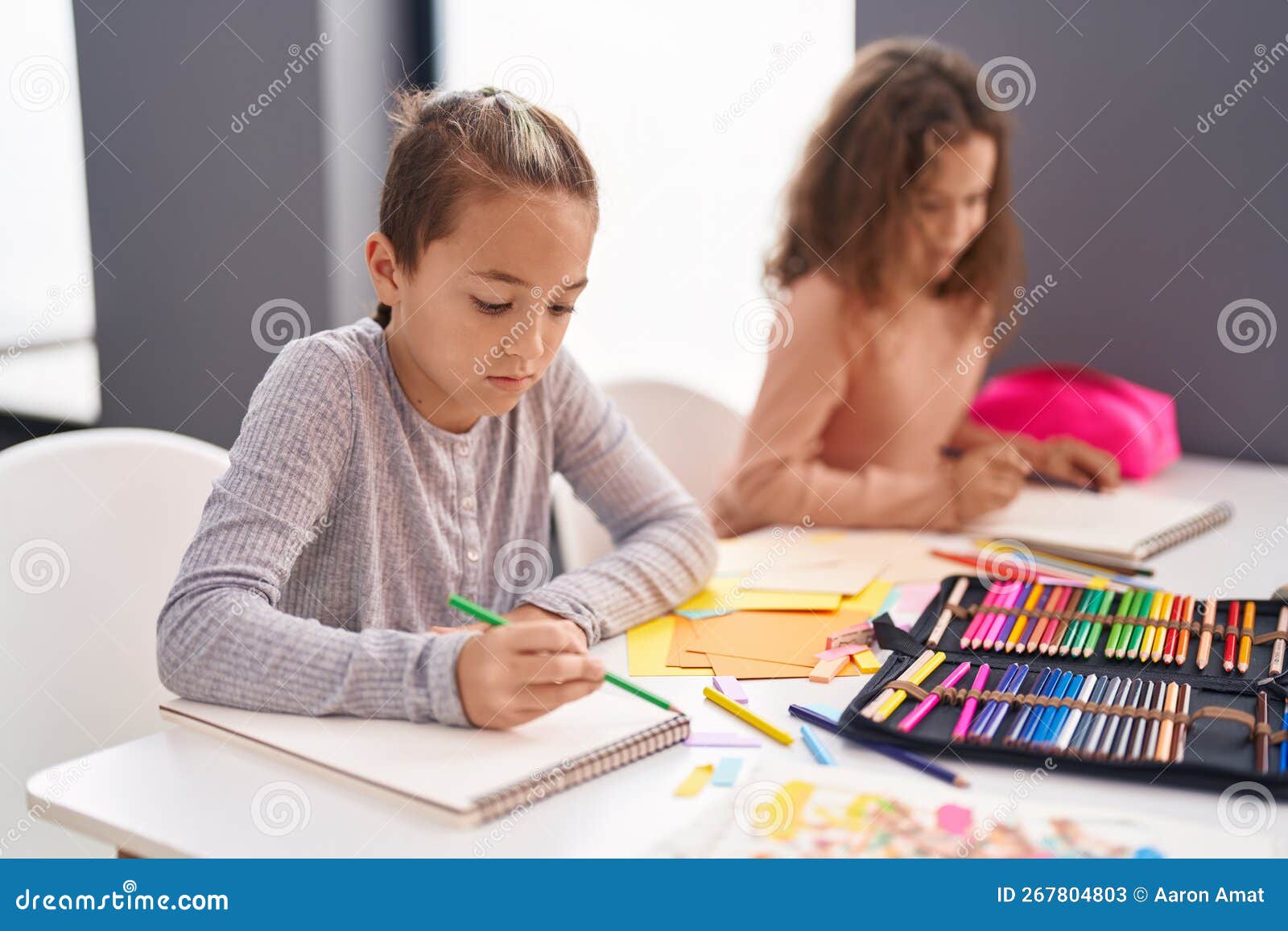 Two Kids Students Sitting on Table Drawing on Notebook Paper at ...