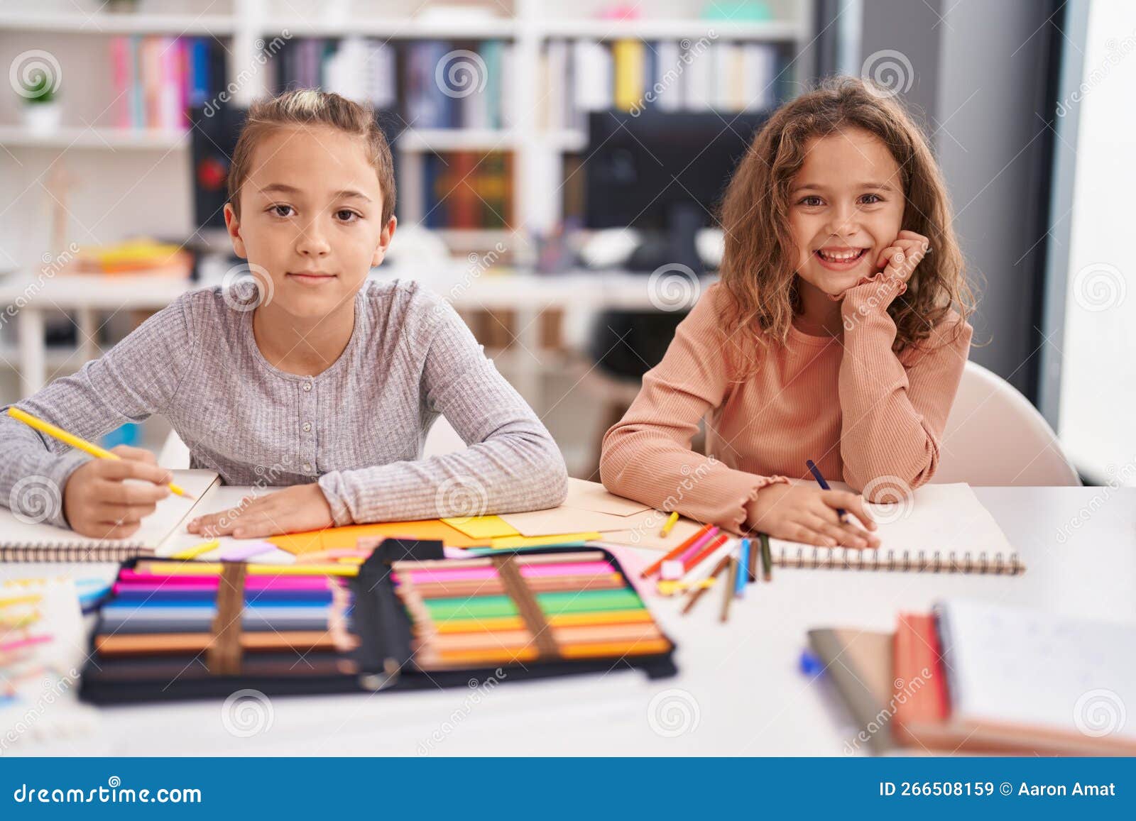 Two Kids Students Sitting on Table Drawing on Notebook Paper at ...
