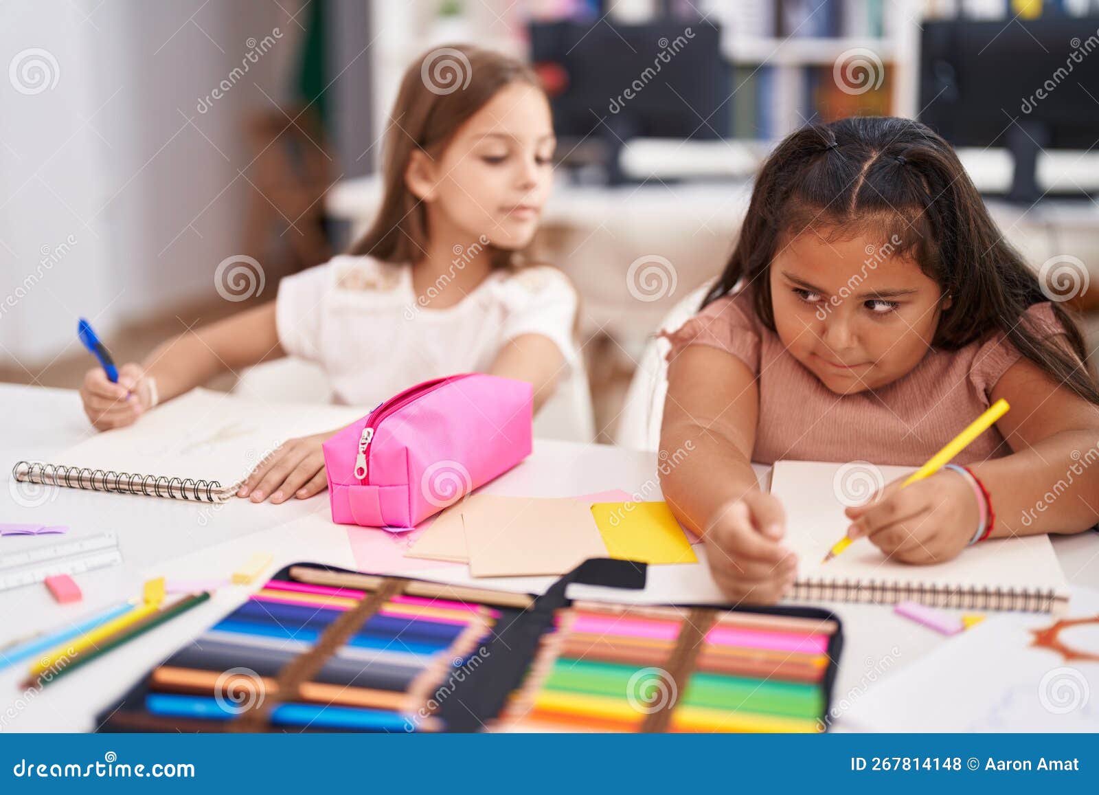 Two Kids Students Sitting on Table Drawing on Notebook Paper at ...