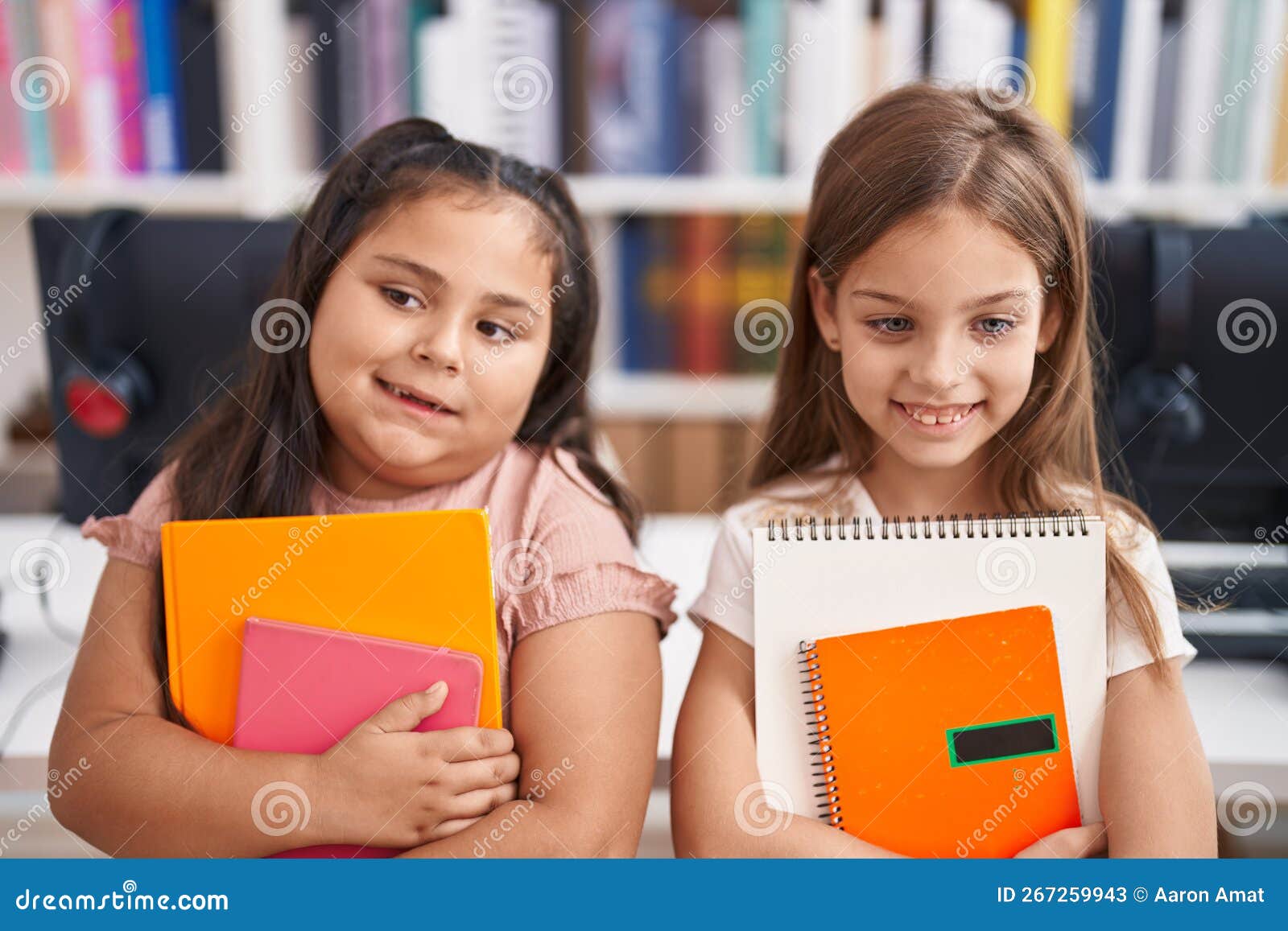 Two Kids Students Smiling Confident Holding Books at Classroom Stock ...
