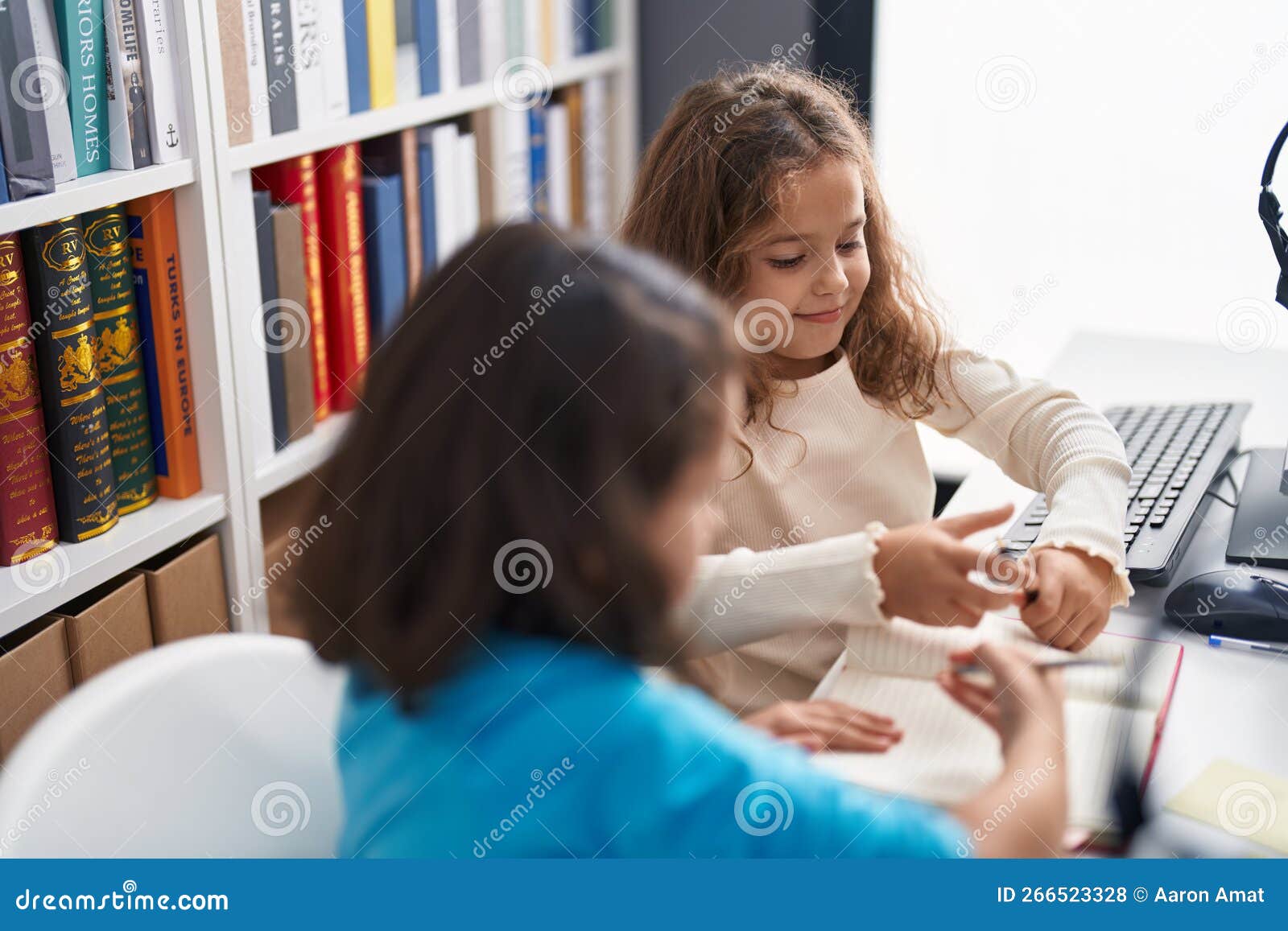 Two Kids Students Using Computer Writing on Notebook at Classroom Stock ...