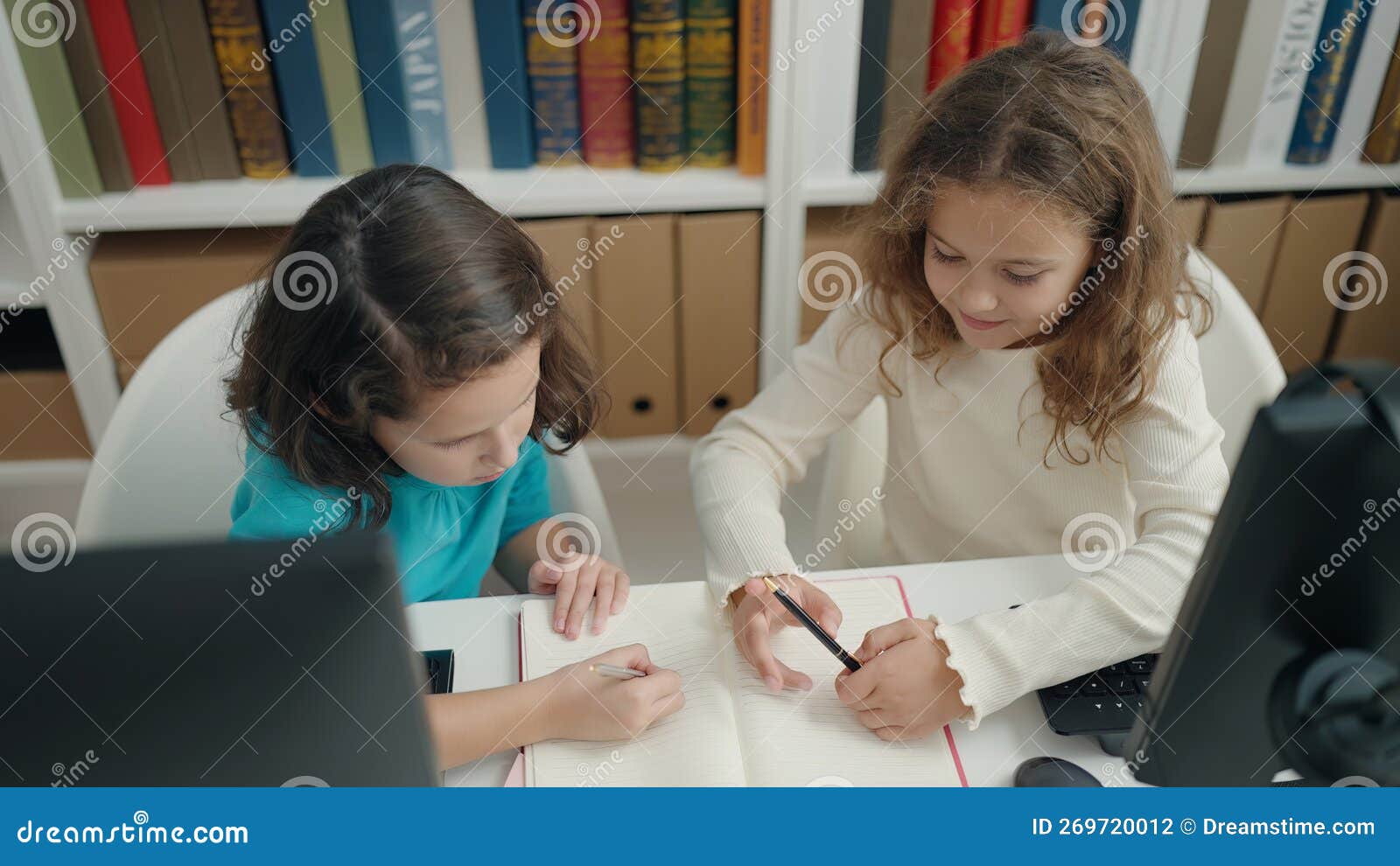 Two Kids Students Using Computer Writing on Notebook at Classroom Stock ...