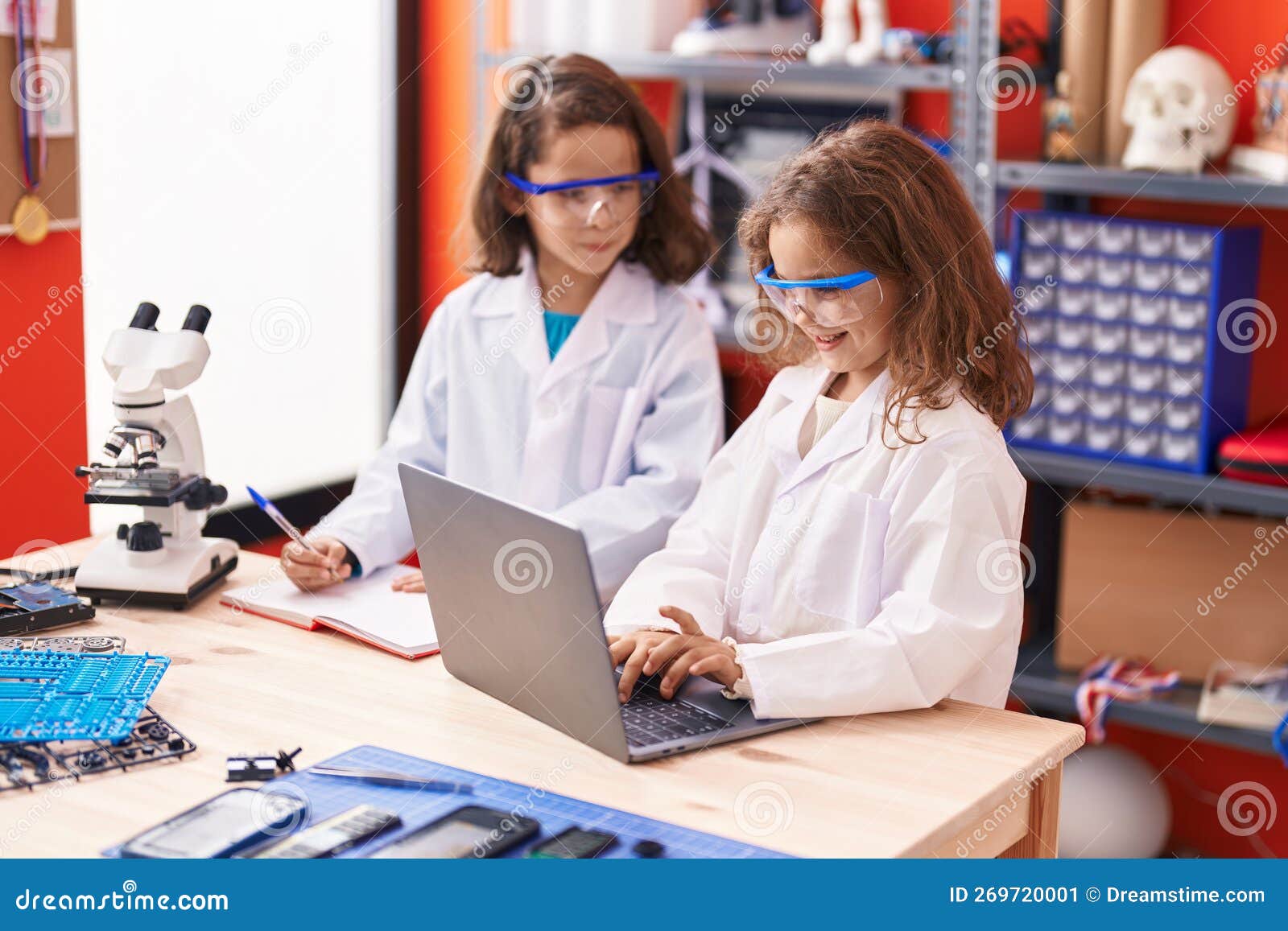 Two Kids Students Using Laptop Writing on Notebook at Laboratory ...