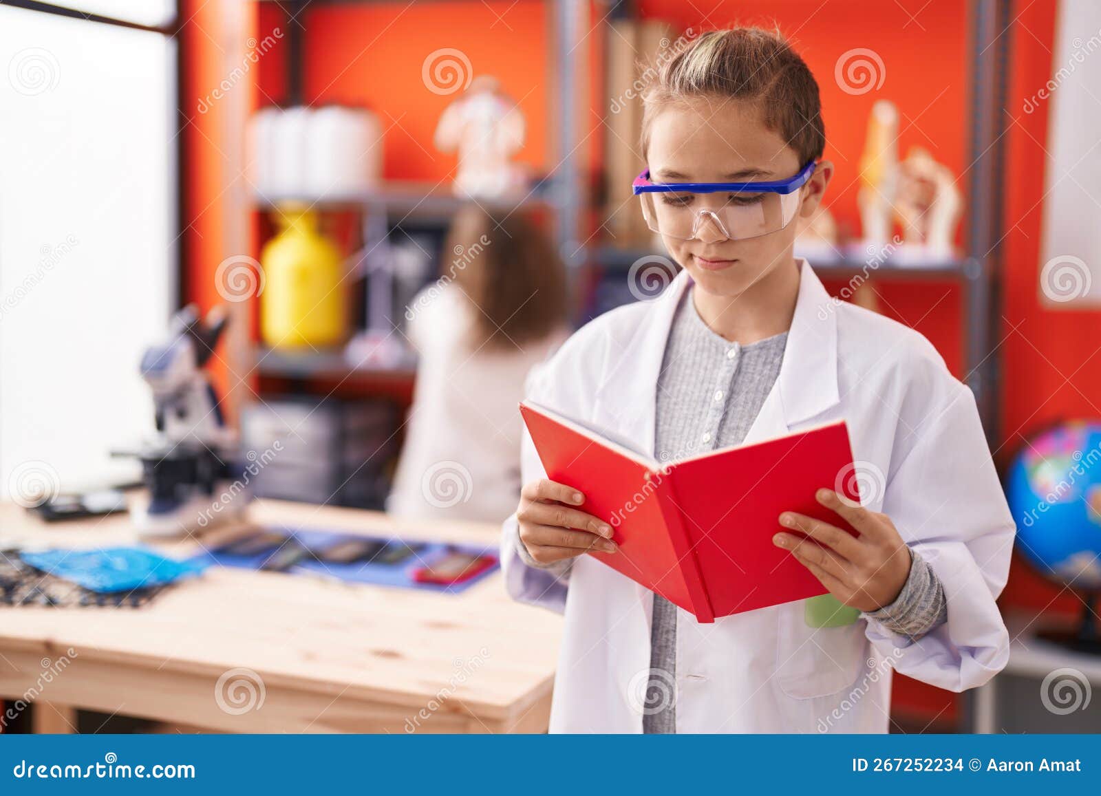 Two Kids Students Using Microscope Reading Notebook at Laboratory ...