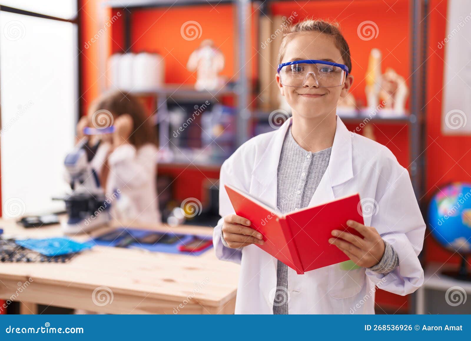 Two Kids Students Using Microscope Reading Notebook at Laboratory ...