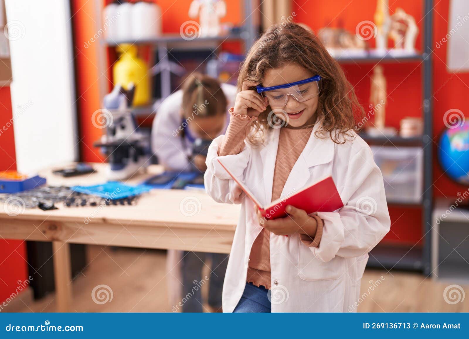 Two Kids Students Using Microscope Reading Notebook at Laboratory ...