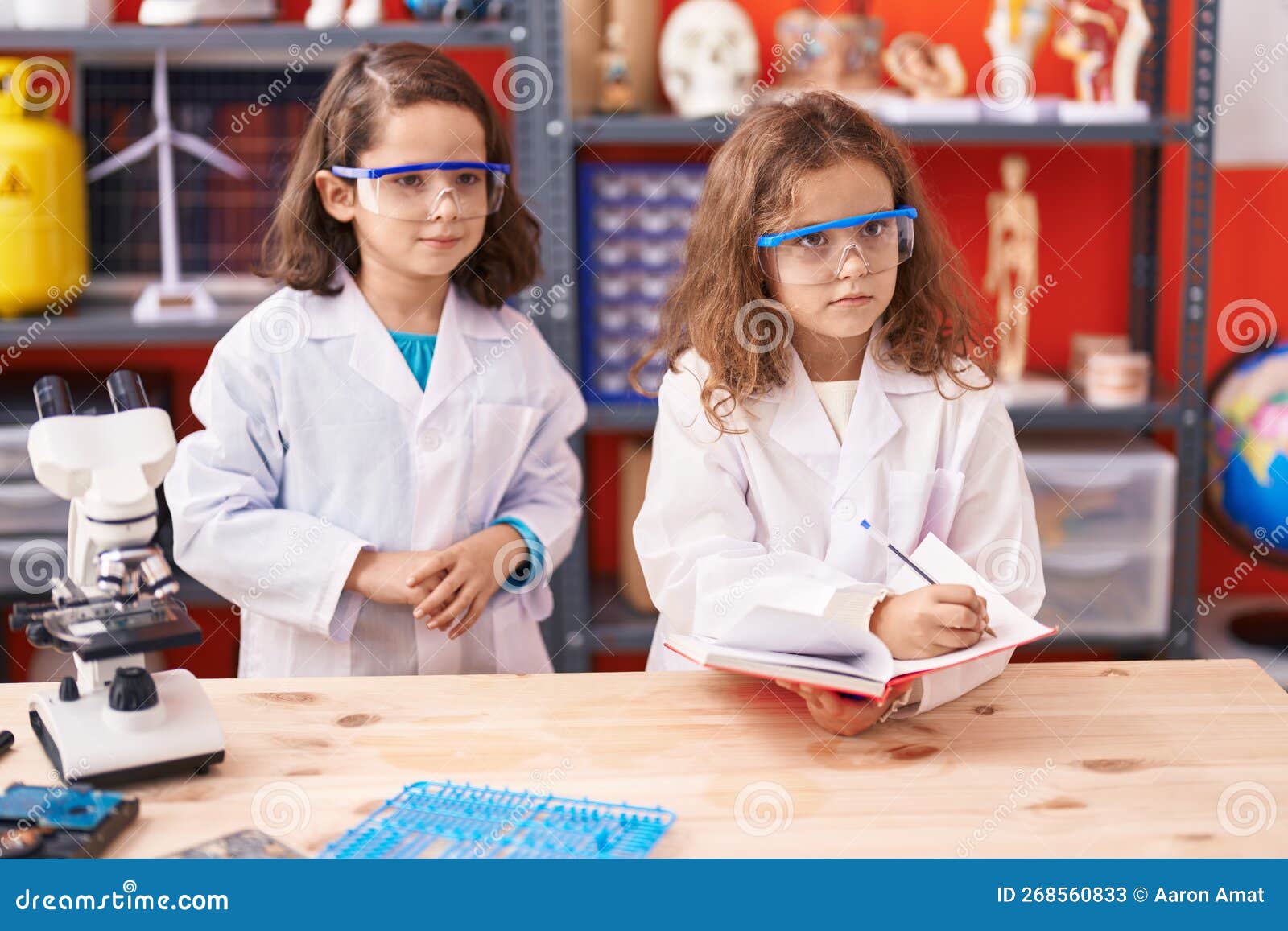 Two Kids Students Using Microscope Writing on Notebook at Kindergarten ...