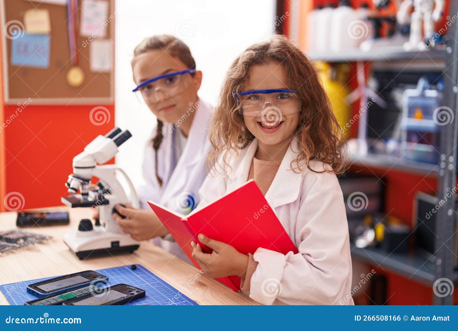 Two Kids Students Using Microscope Writing on Notebook at Laboratory ...