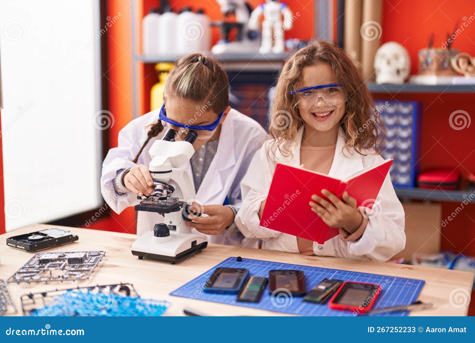 Two Kids Students Using Microscope Writing on Notebook at Laboratory ...