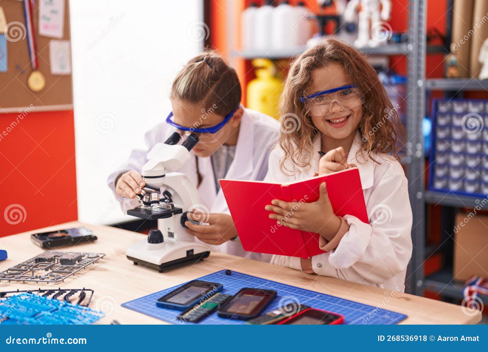 Two Kids Students Using Microscope Writing on Notebook at Laboratory ...