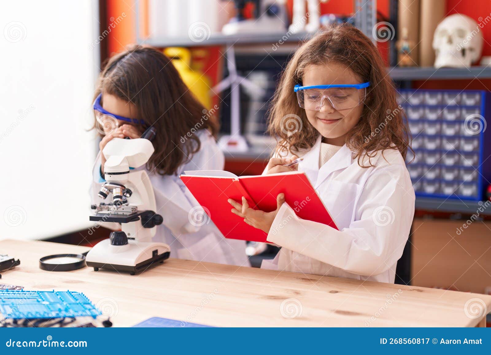 Two Kids Students Using Microscope Writing on Notebook at Laboratory ...