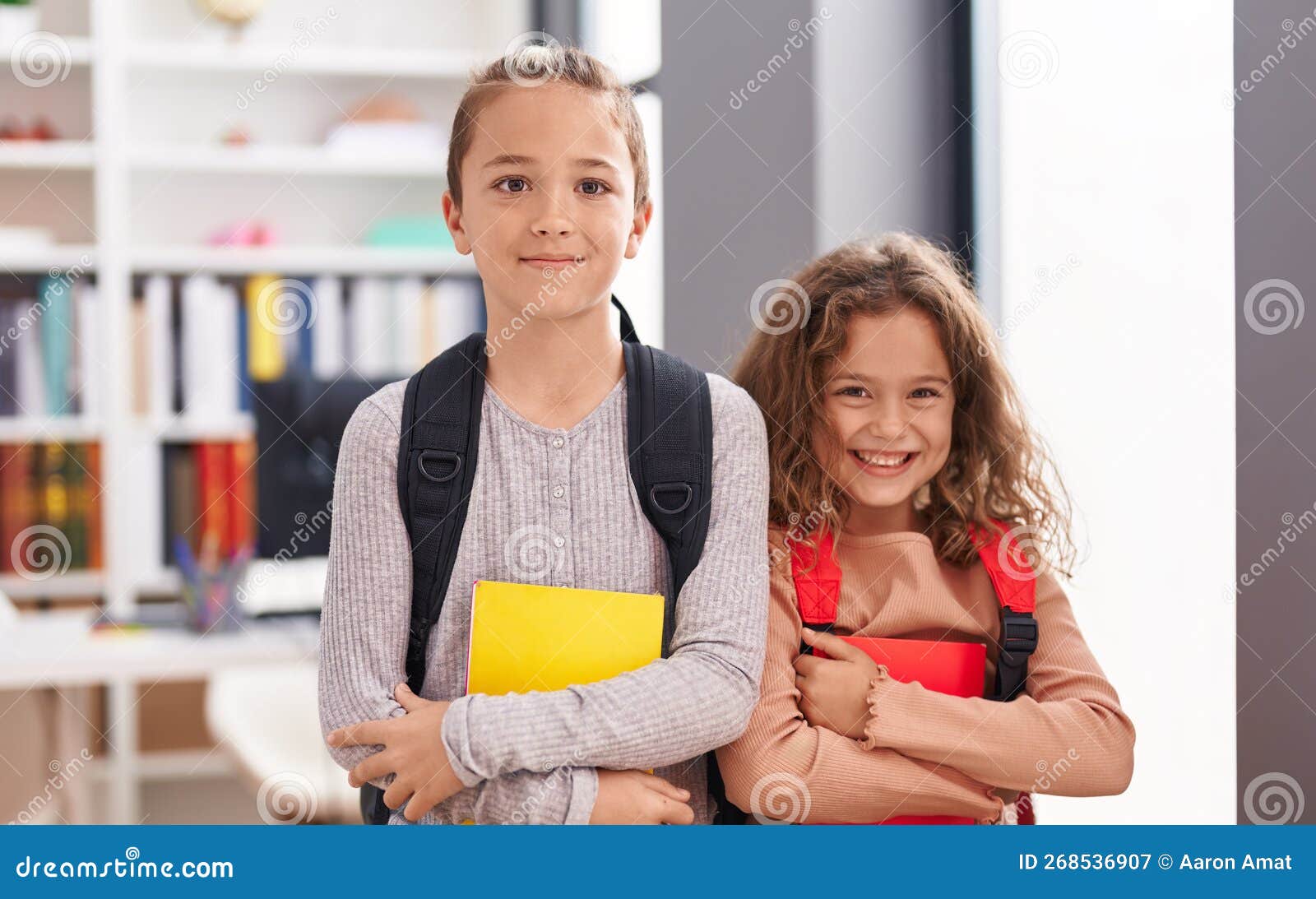 Two Kids Students Wearing Backpack Holding Book at Classroom Stock ...