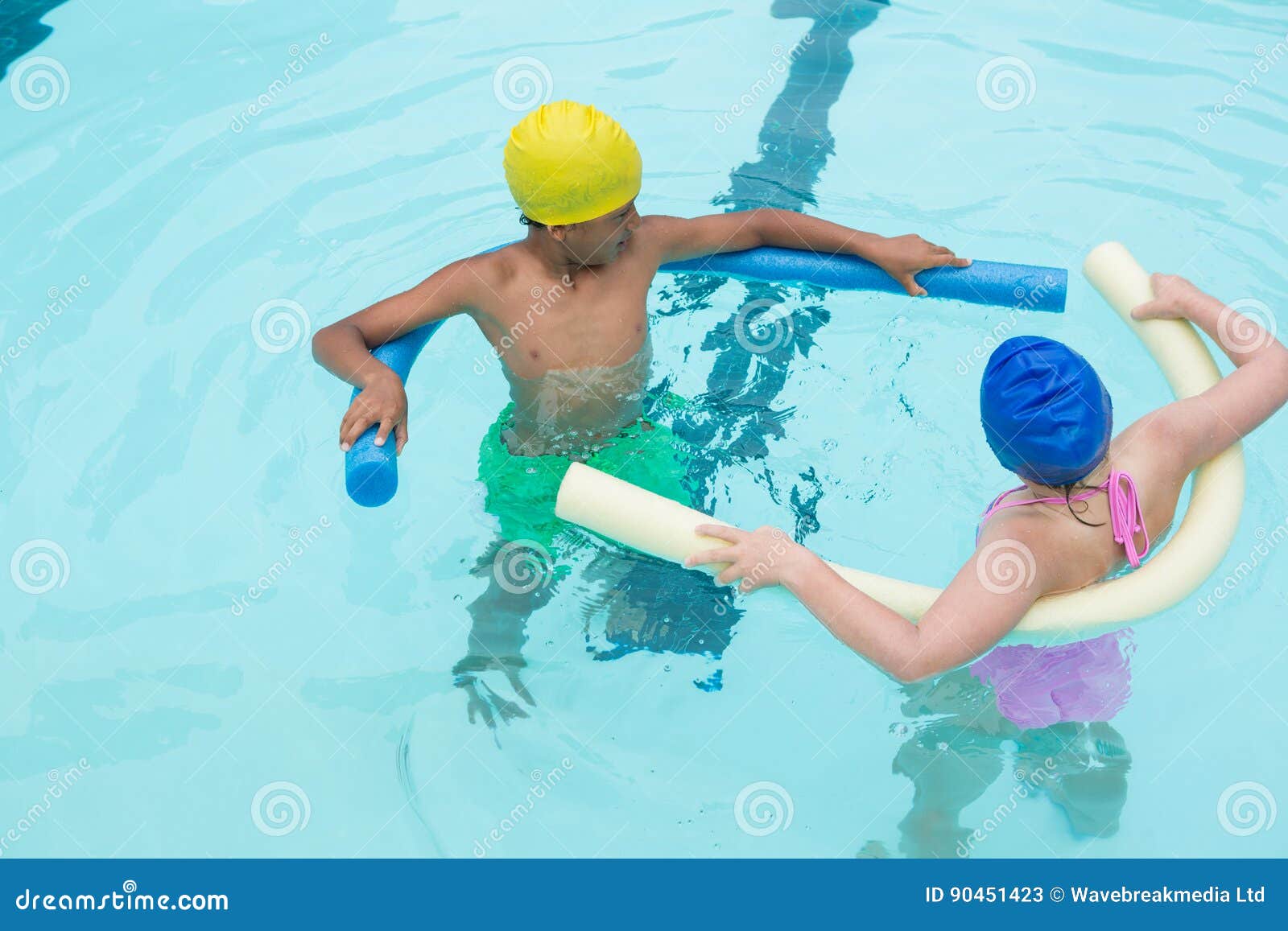 Two kids swimming in pool stock image. Image of confidence - 90451423