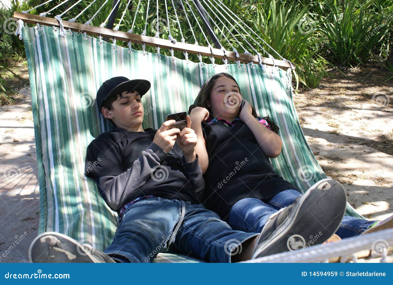 Two Kids Texting and Talking on Phone Stock Image - Image of ...