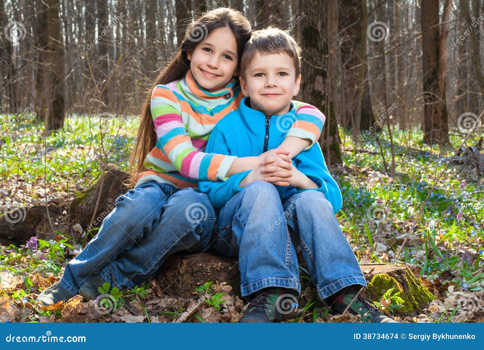 Two Kids Together Sitting in the Forest Stock Photo - Image of bright ...