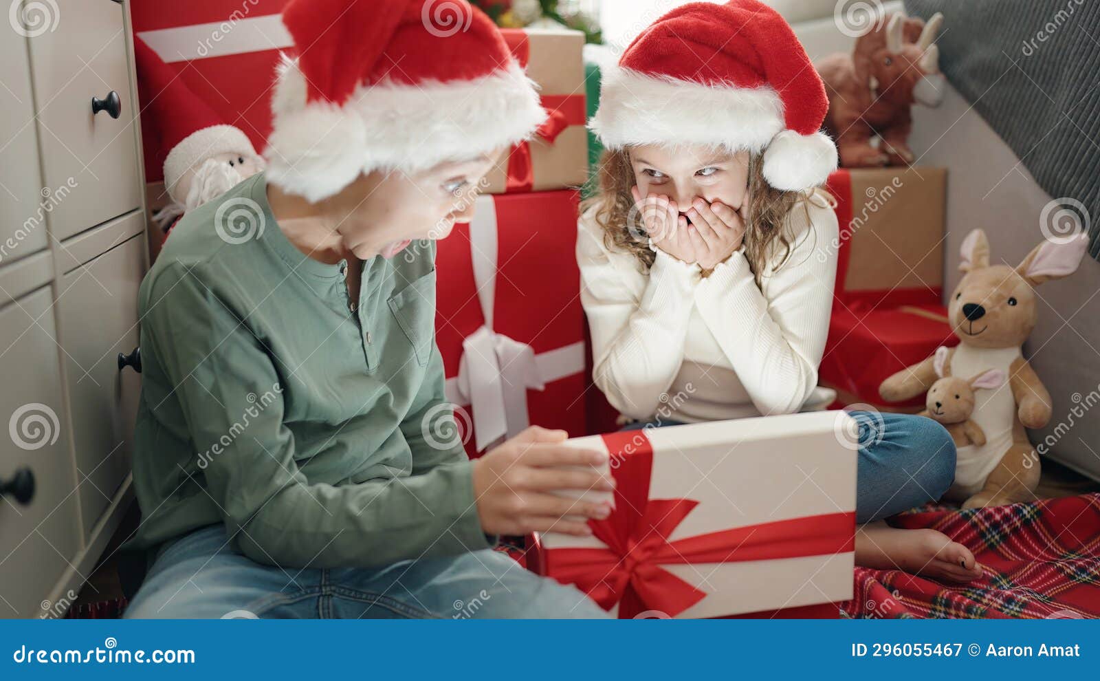Two Kids Unpacking Gift Sitting on Floor by Christmas Tree at Home ...