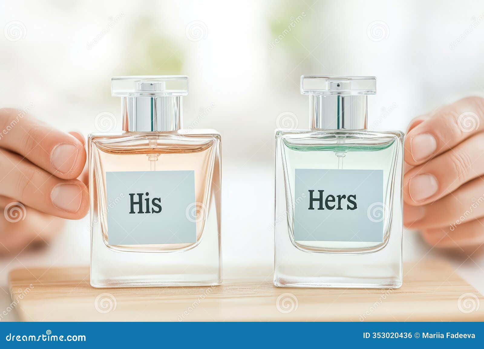 Two Labeled Perfume Bottles Marked "His" and "Hers," Held Gently by ...