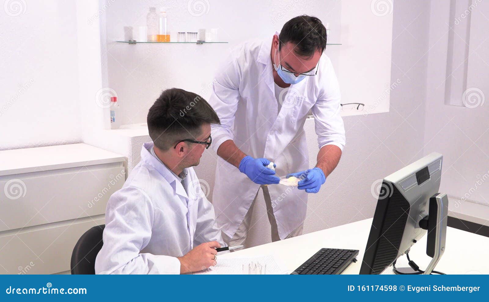 Two Lab Workers Research Microbiology and Chemistry with ...
