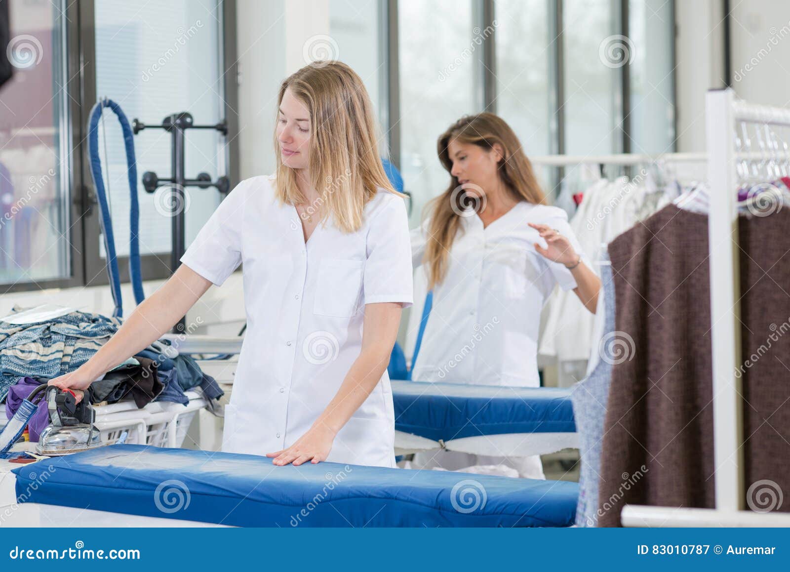 Two Ladies Working in Dry Cleaners Stock Image - Image of clean ...