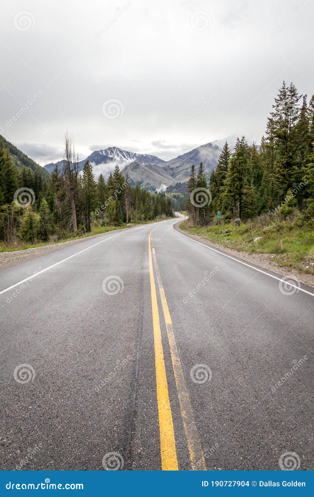 Two Lane Road in Mountains stock photo. Image of snow - 190727904