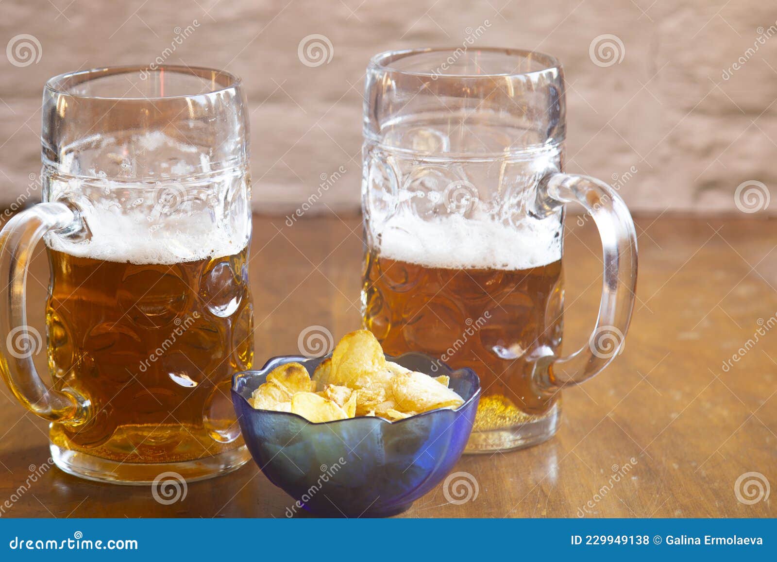Two Large Mugs of Beer and Chips on a Wooden Table Stock Photo - Image ...