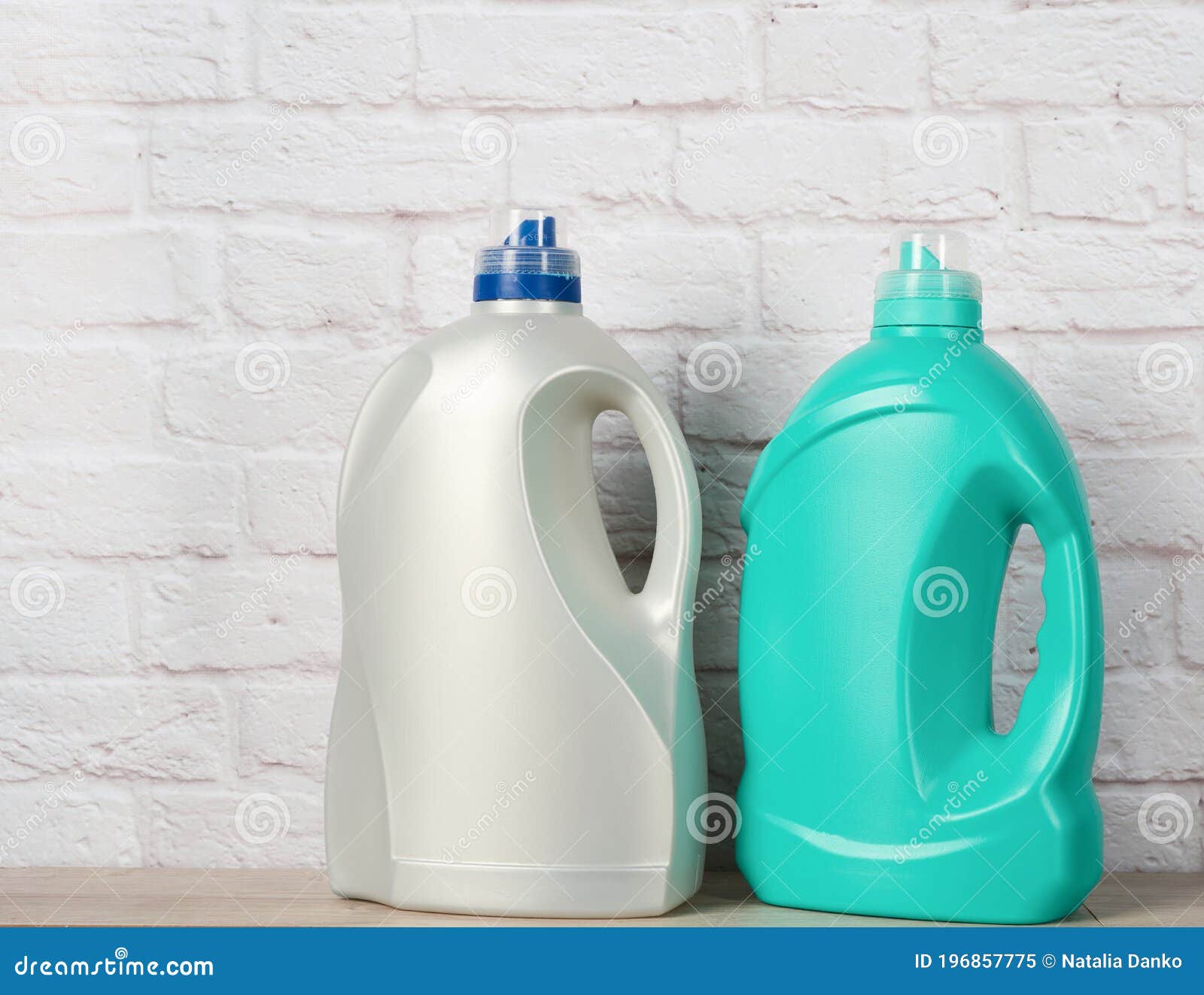 Two Large Plastic Bottles with Liquid Detergent on White Brick Wall ...