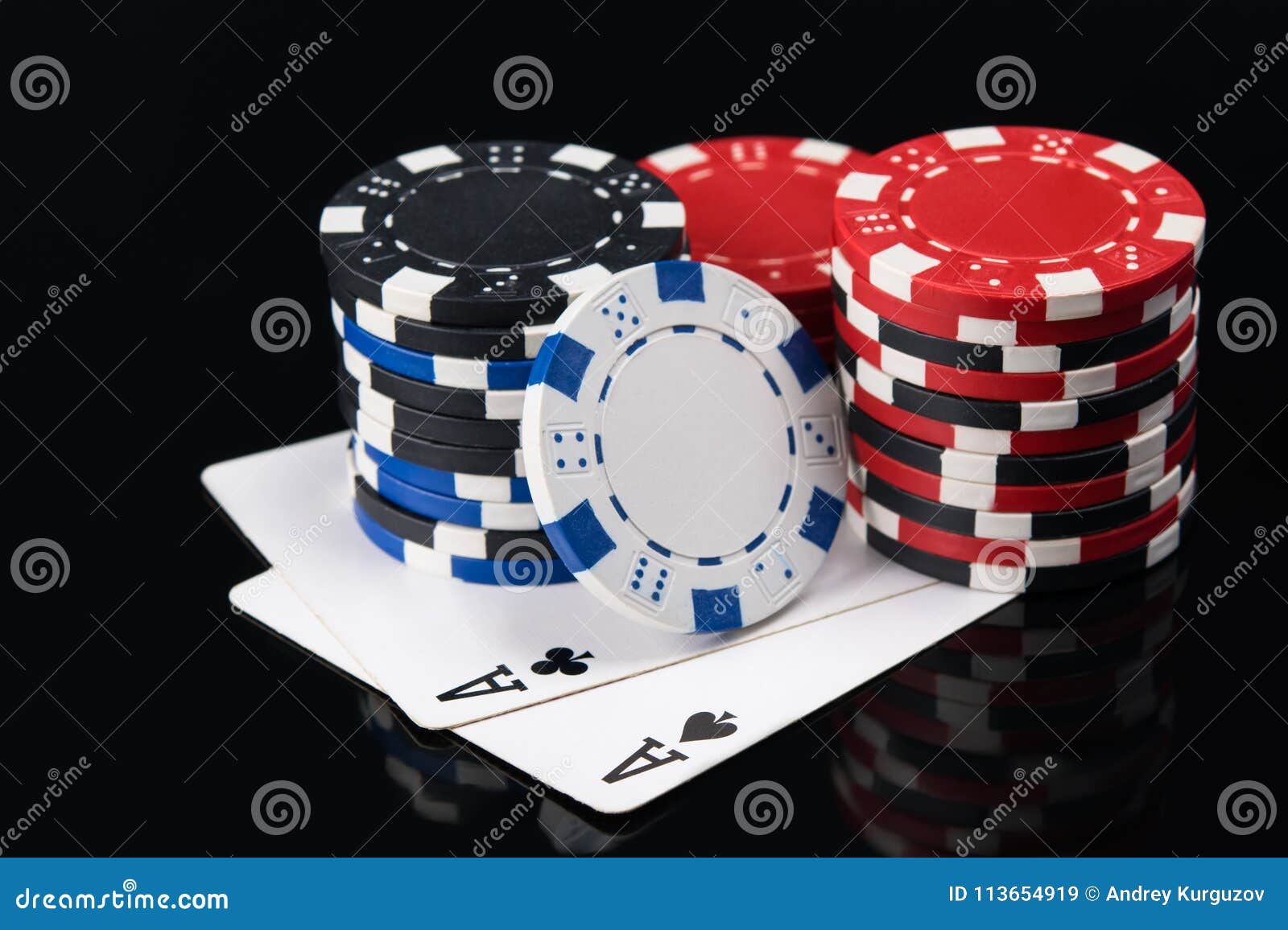 Two Large Playing Cards with Poker Chips on a Dark Background Stock ...