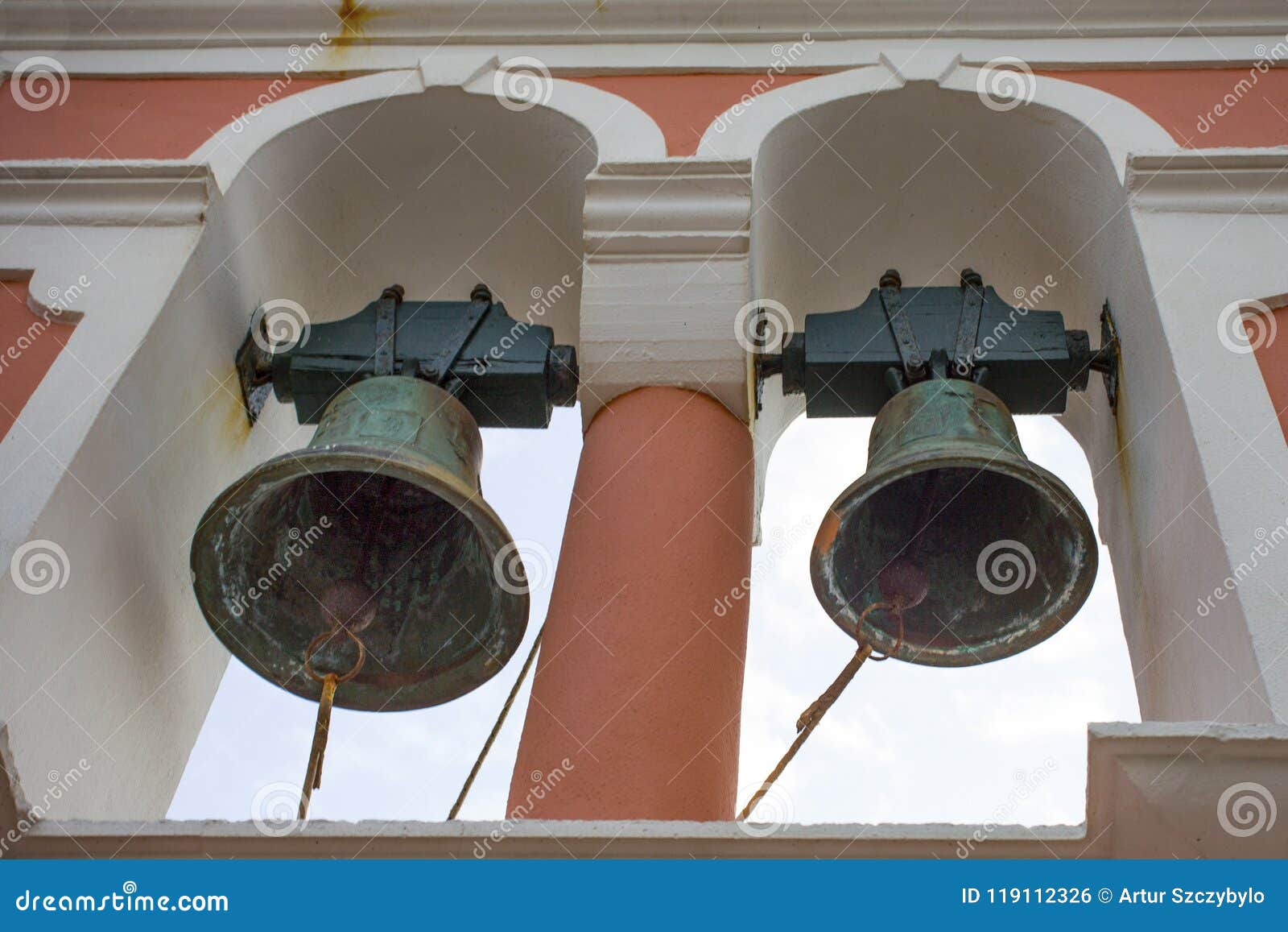 Two Large Rustic Church Bells Above The Structure. The Building Is ...