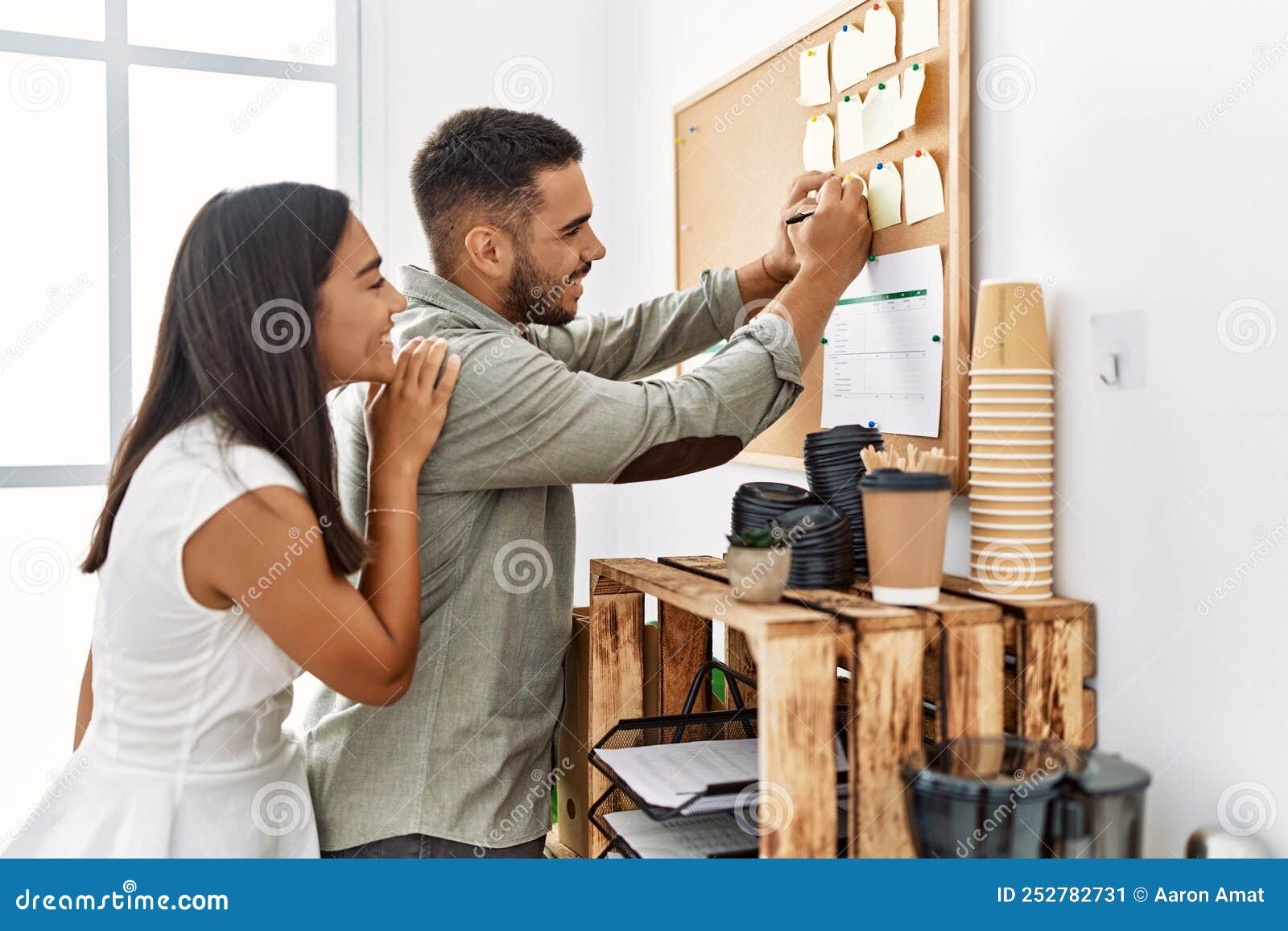Two Latin Business Workers Smiling Happy Writing on Corkboard Working ...