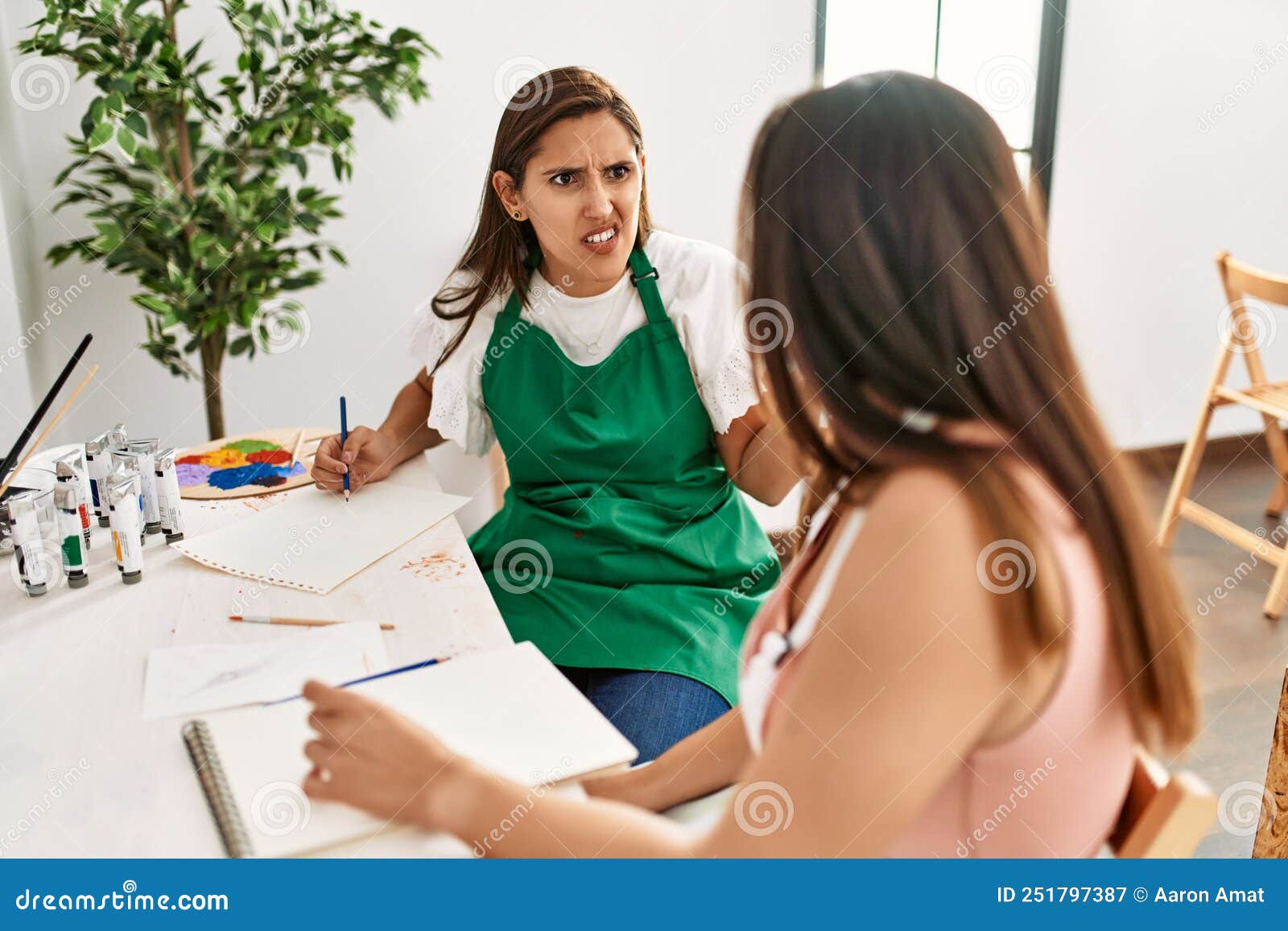 Two Latin Paint Students Arguing Sitting on the Table at Art School ...