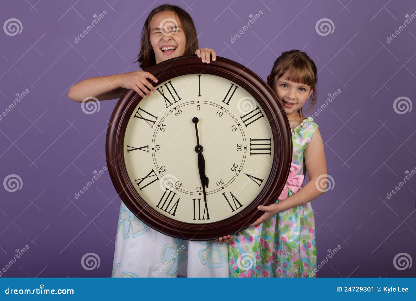 Two Laughing Girls Holding a Large Wall Clock Stock Image - Image of ...