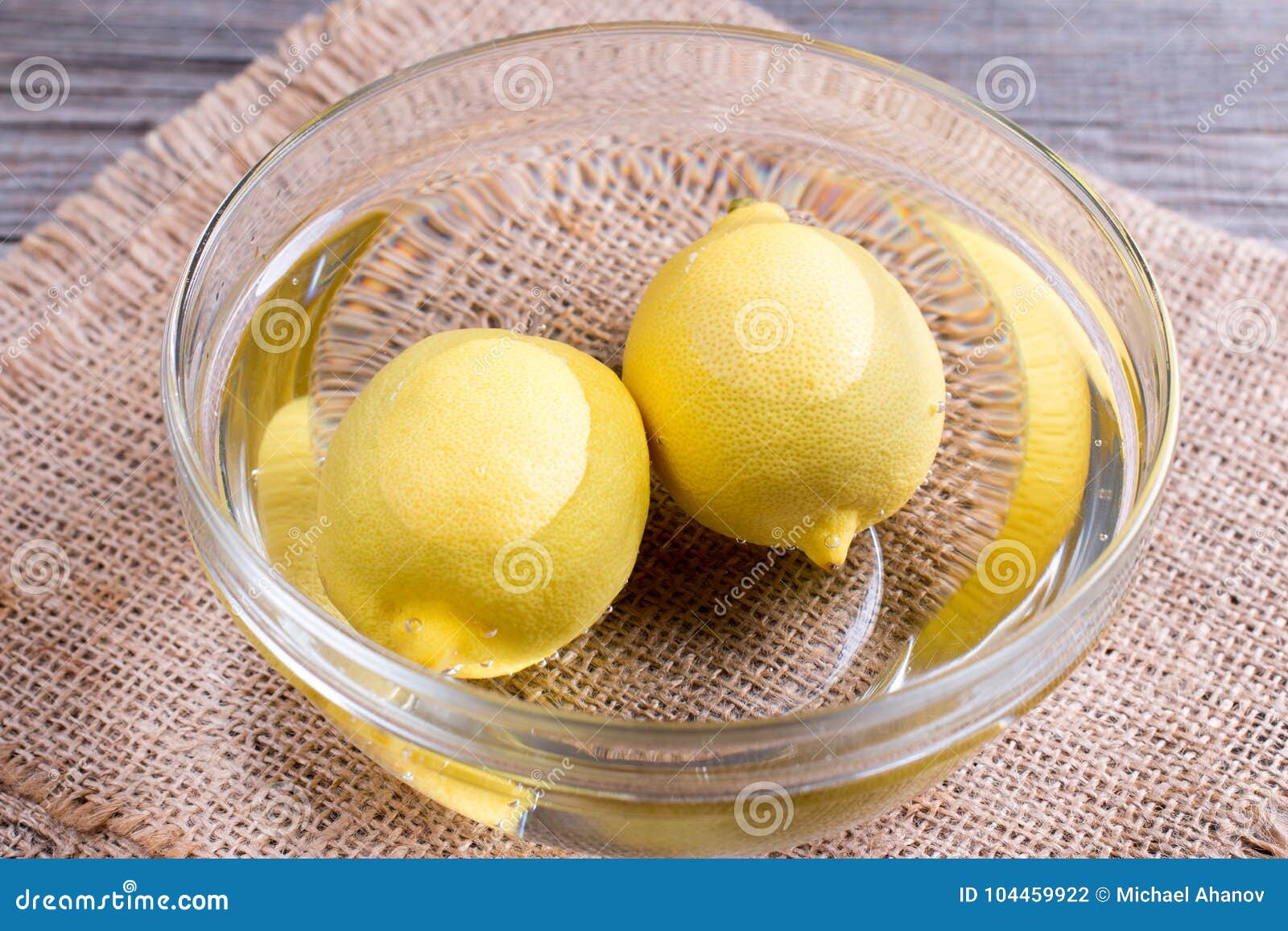 Two Lemons in a Bowl of Water Stock Photo - Image of closeup, close ...