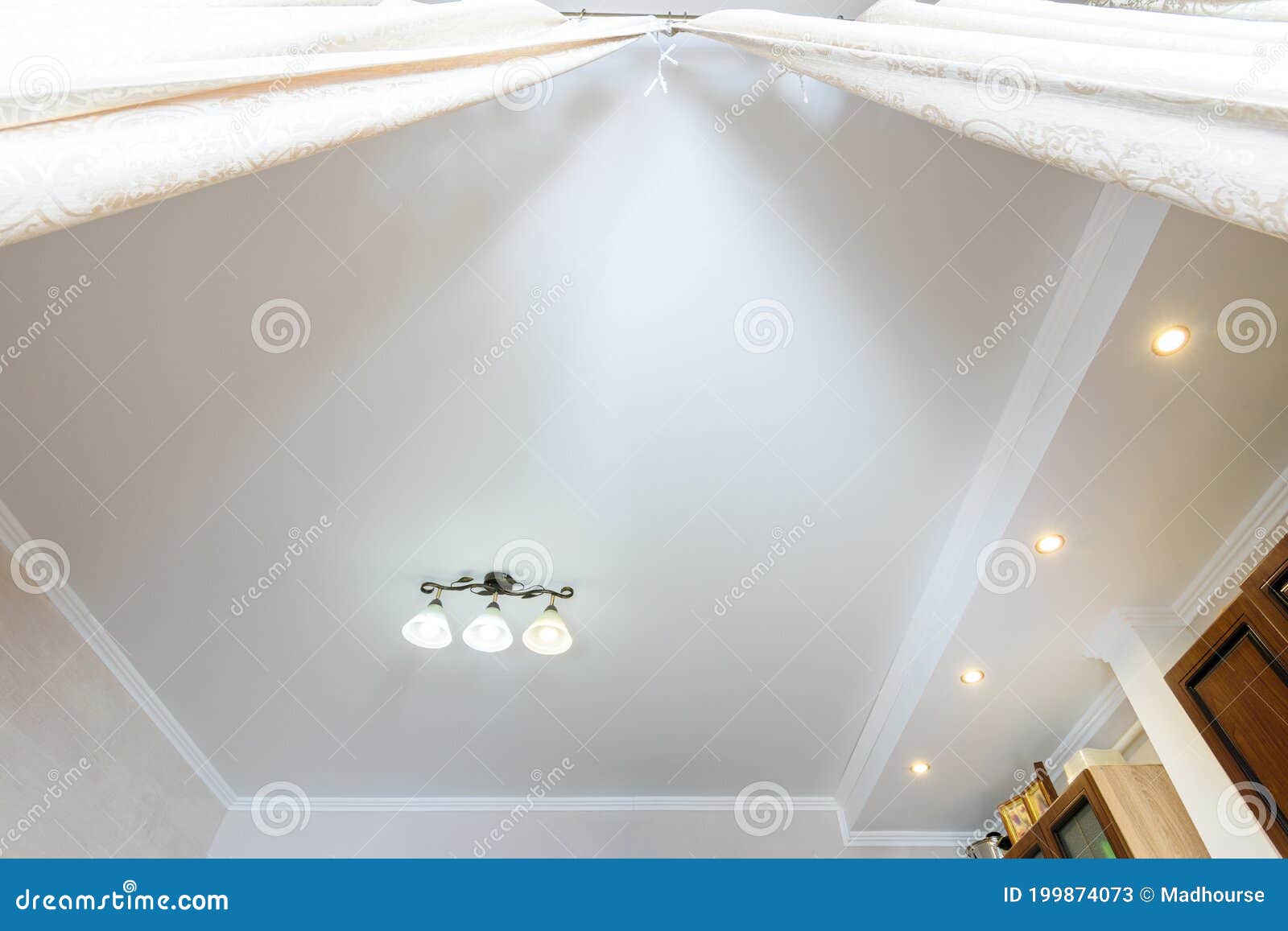 Two-level Ceiling with a Small Chandelier in the Interior of the Room ...