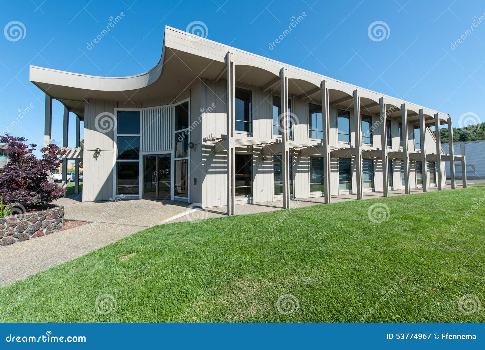 Two Level Office Building with Grass Next To it Stock Image - Image of ...