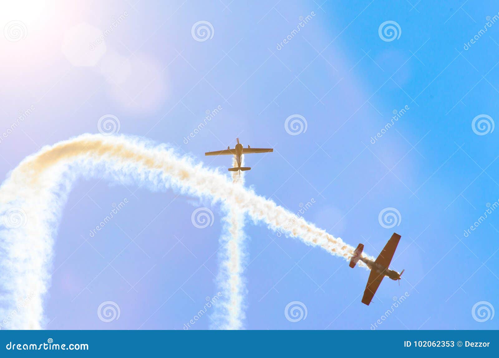 Two Light Engine Aircraft with a Trace of White Smoke Fly in the Blue ...