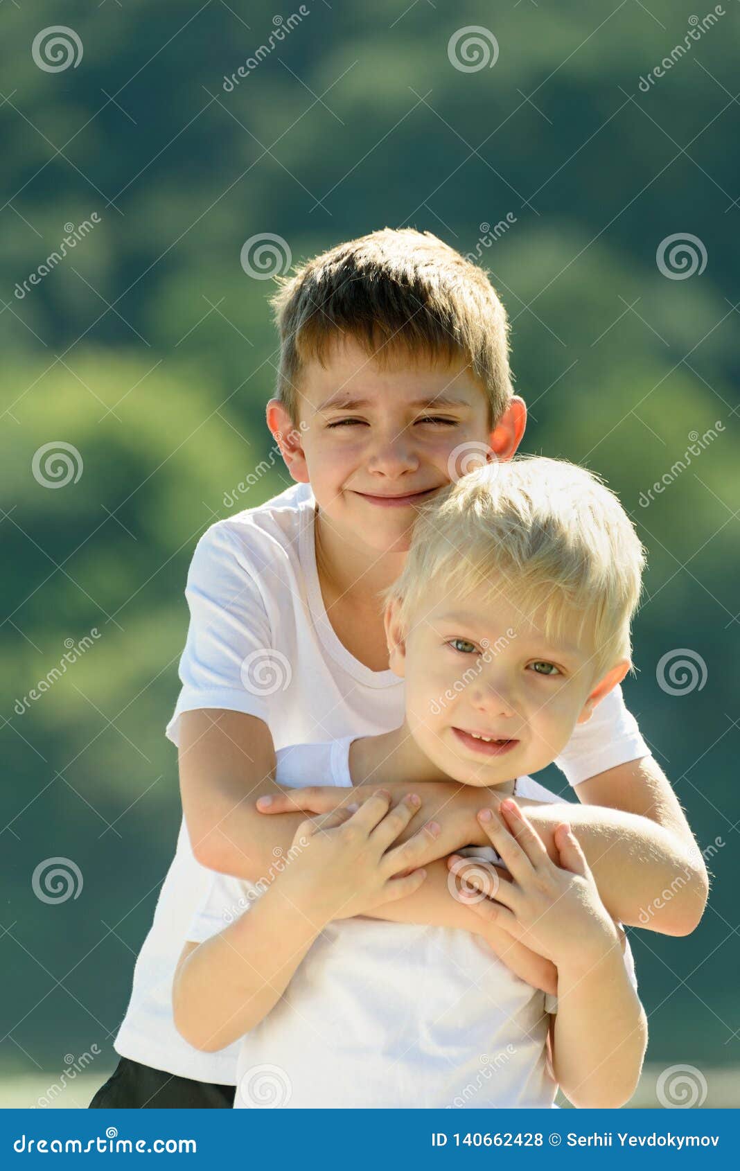 Two Little Boys are Hugging Outdoors. Concept of Friendship and ...
