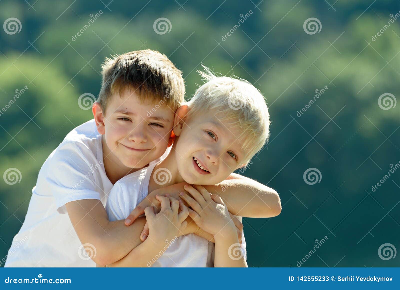 Two Little Boys are Hugging Outdoors. Concept of Friendship and ...
