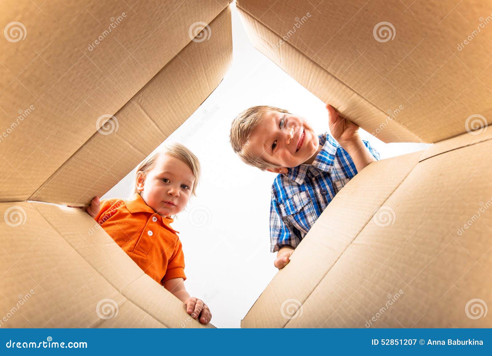 Two Little Boys Opening Cardboard Box and Looking Stock Image - Image ...