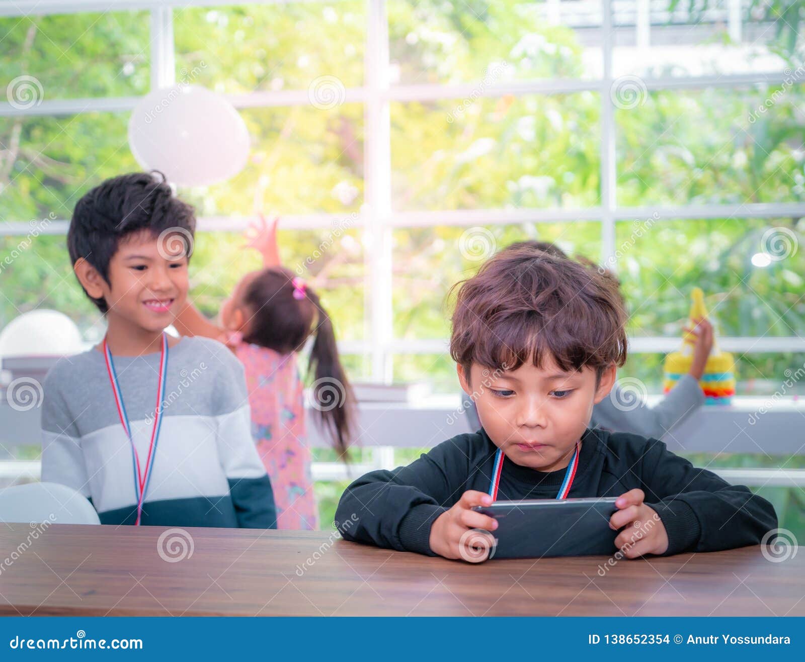 Two Little Boys Playing Online Game on Mobile Phone Stock Photo - Image ...